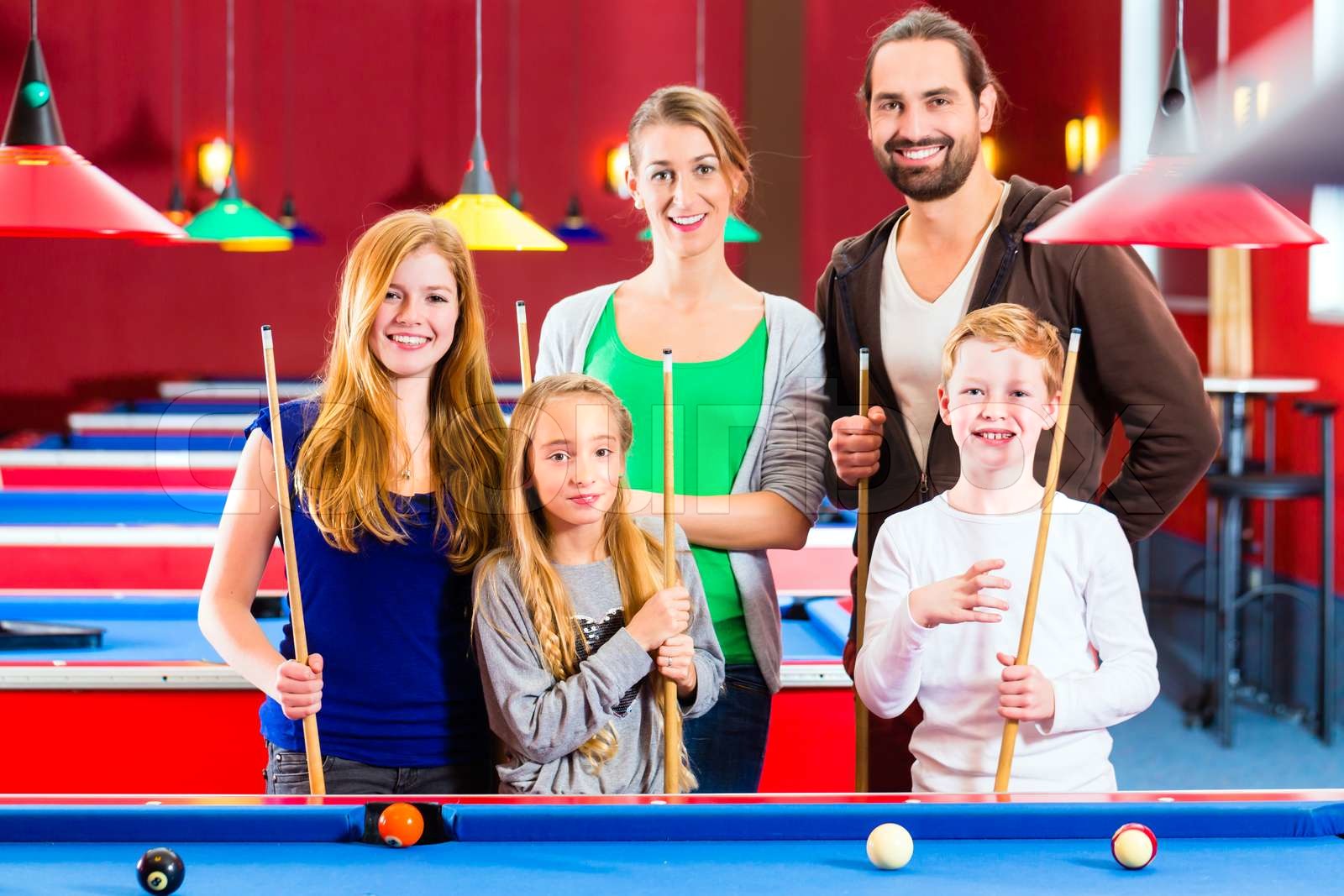 Family playing pool billiard game | Stock image | Colourbox