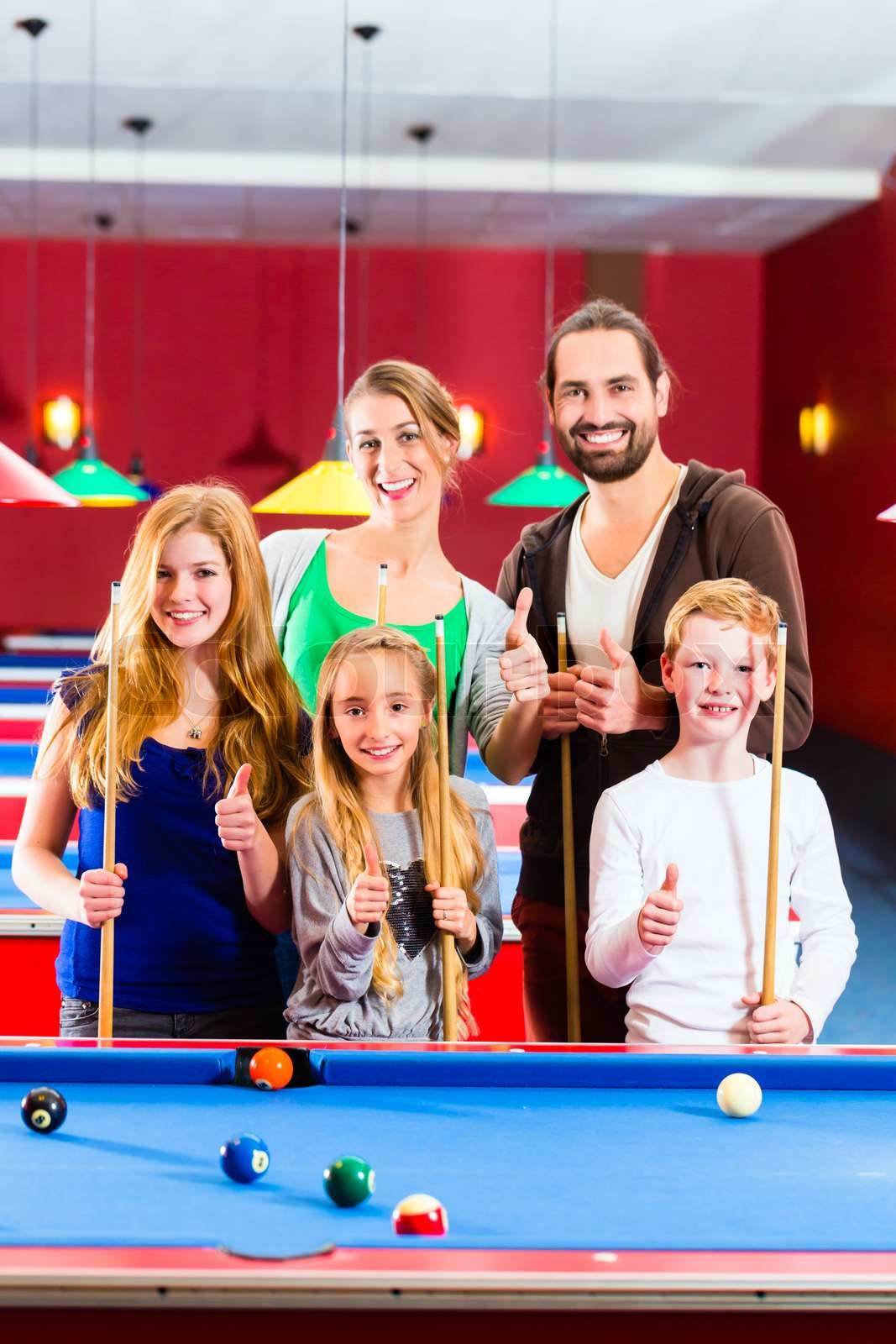 Family playing pool billiard game | Stock image | Colourbox