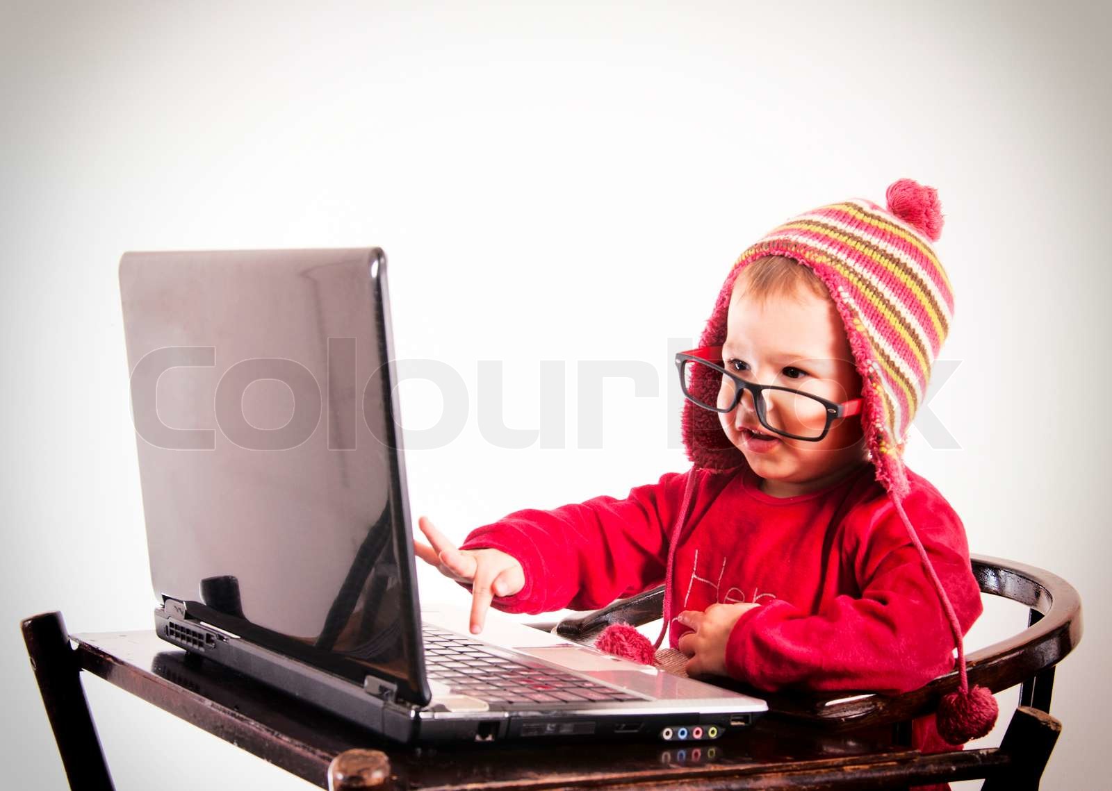 Baby typing on keyboard | Stock image | Colourbox