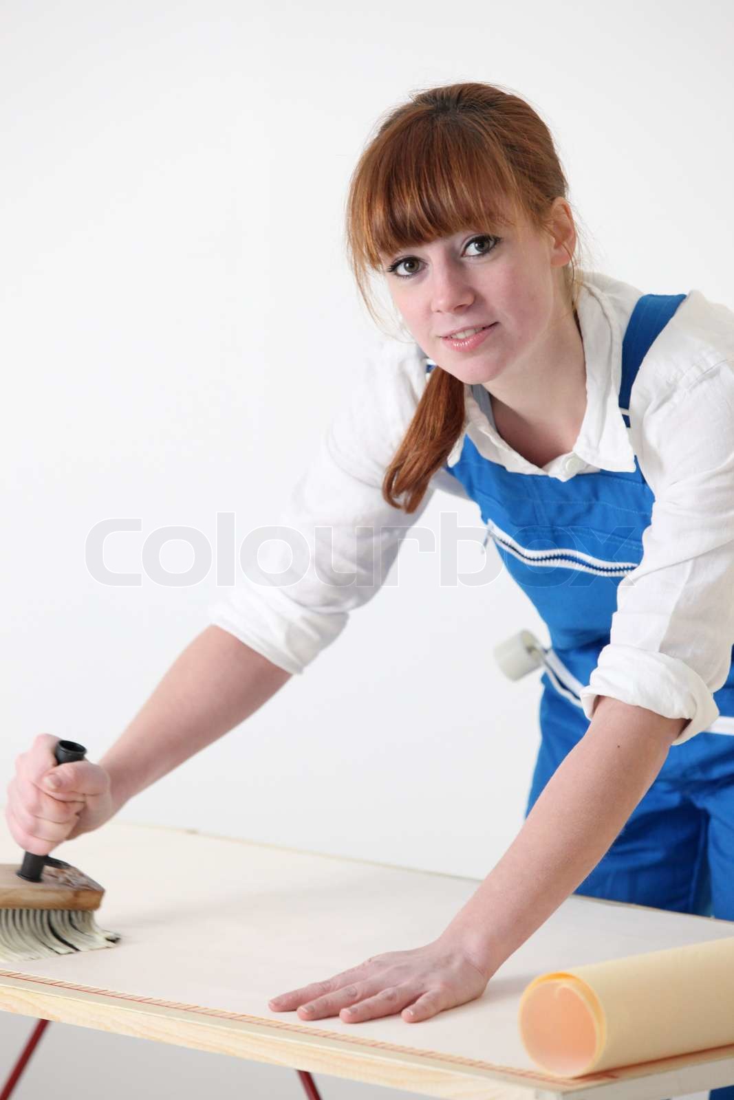 Female decorator with wallpaper | Stock image | Colourbox