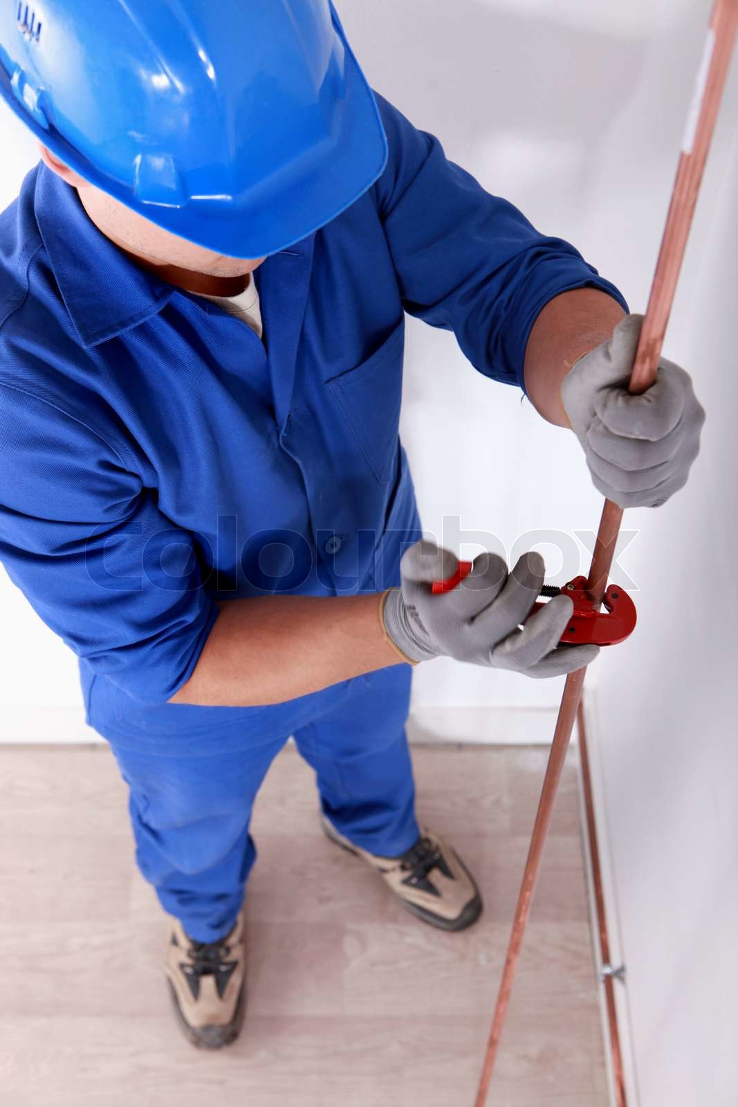 Tradesman using a tool | Stock image | Colourbox