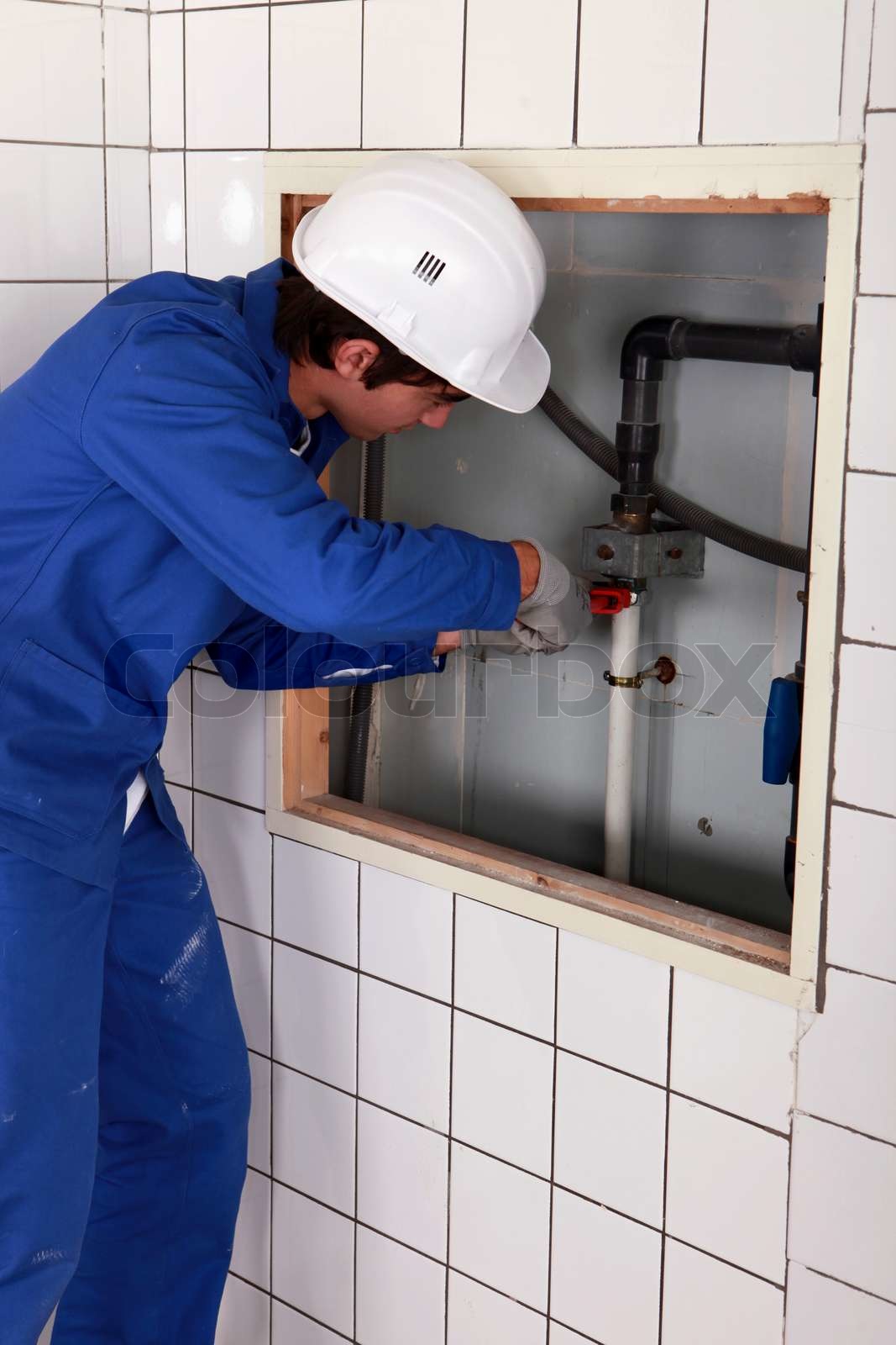 Young plumber working | Stock image | Colourbox
