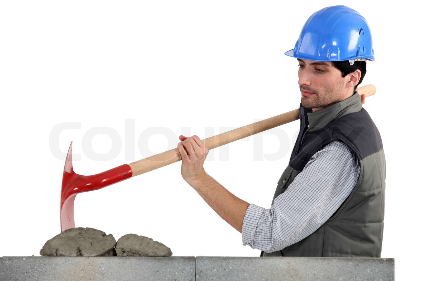 Worker with spade and cement | Stock image | Colourbox