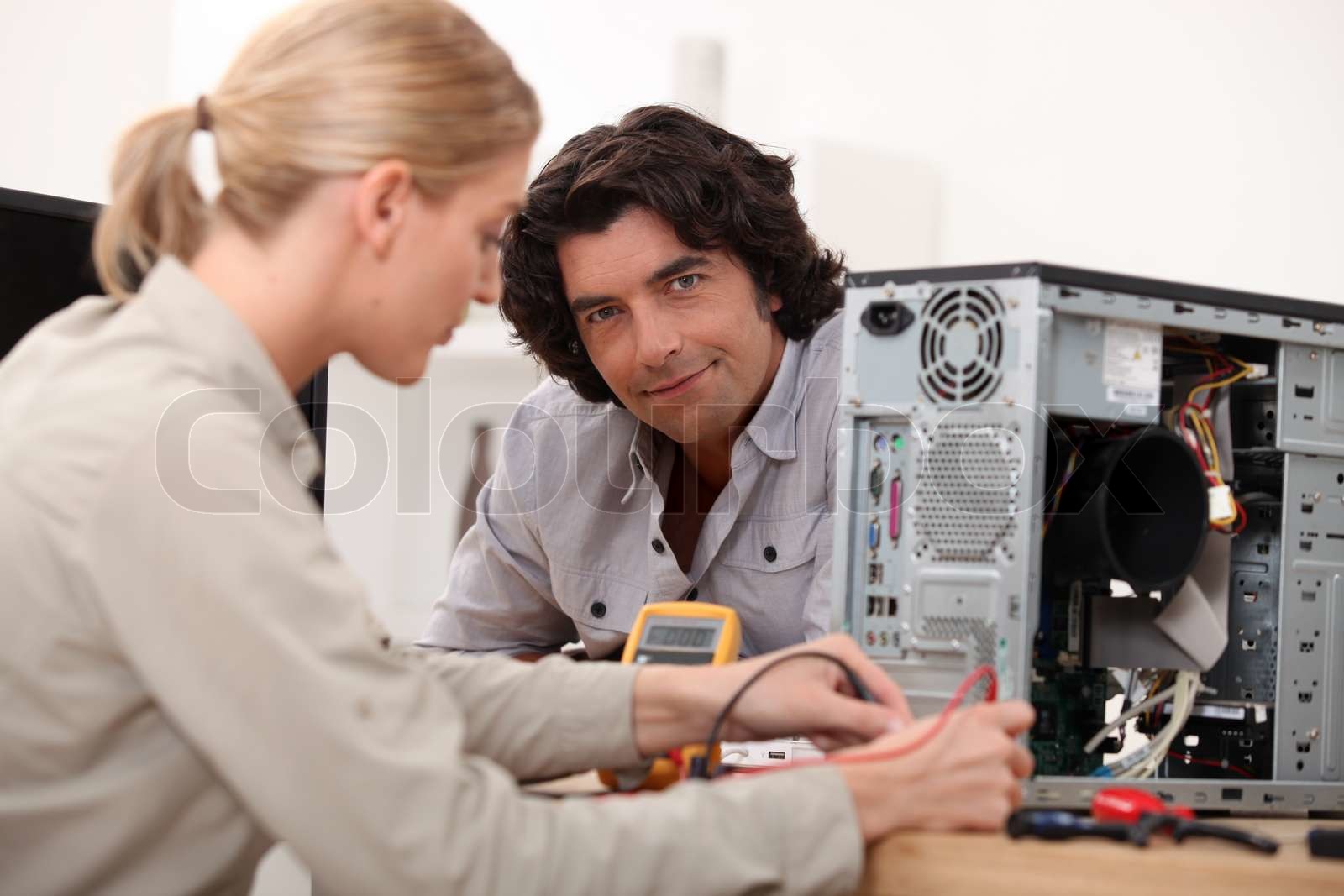 Woman fixing a computer | Stock image | Colourbox
