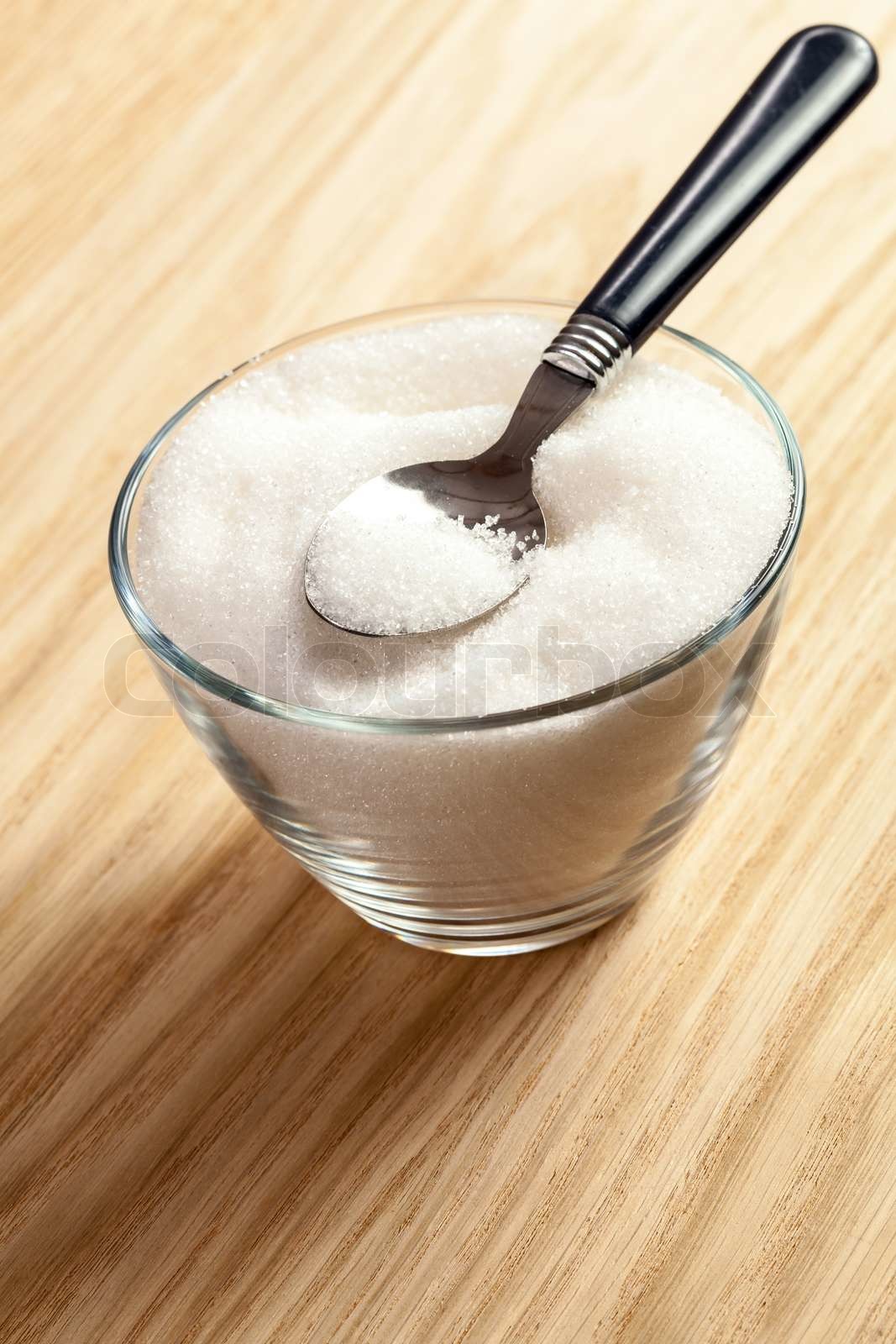 Spoon in a bowl of sugar | Stock image | Colourbox
