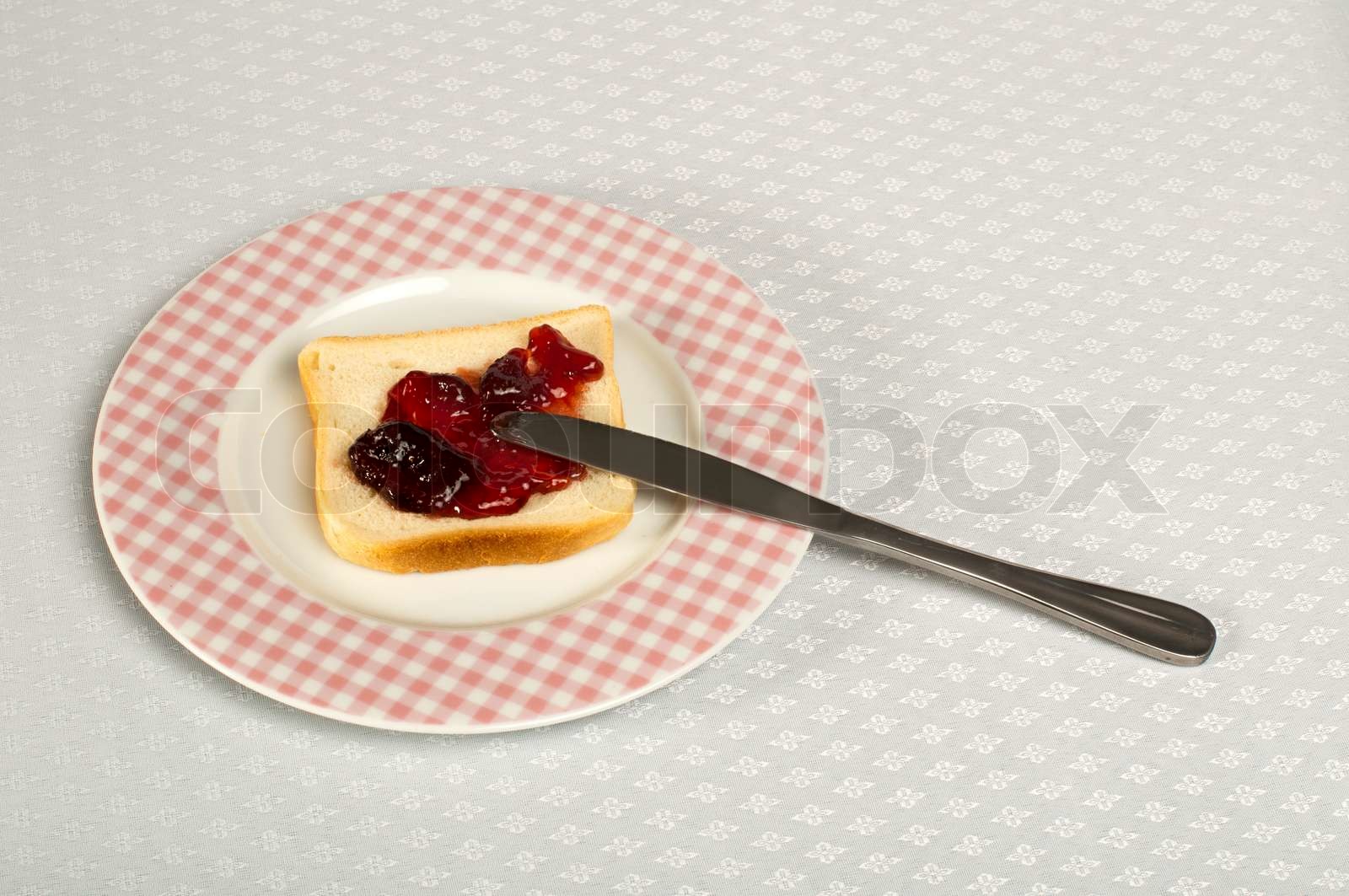 Spread jam on bread | Stock image | Colourbox