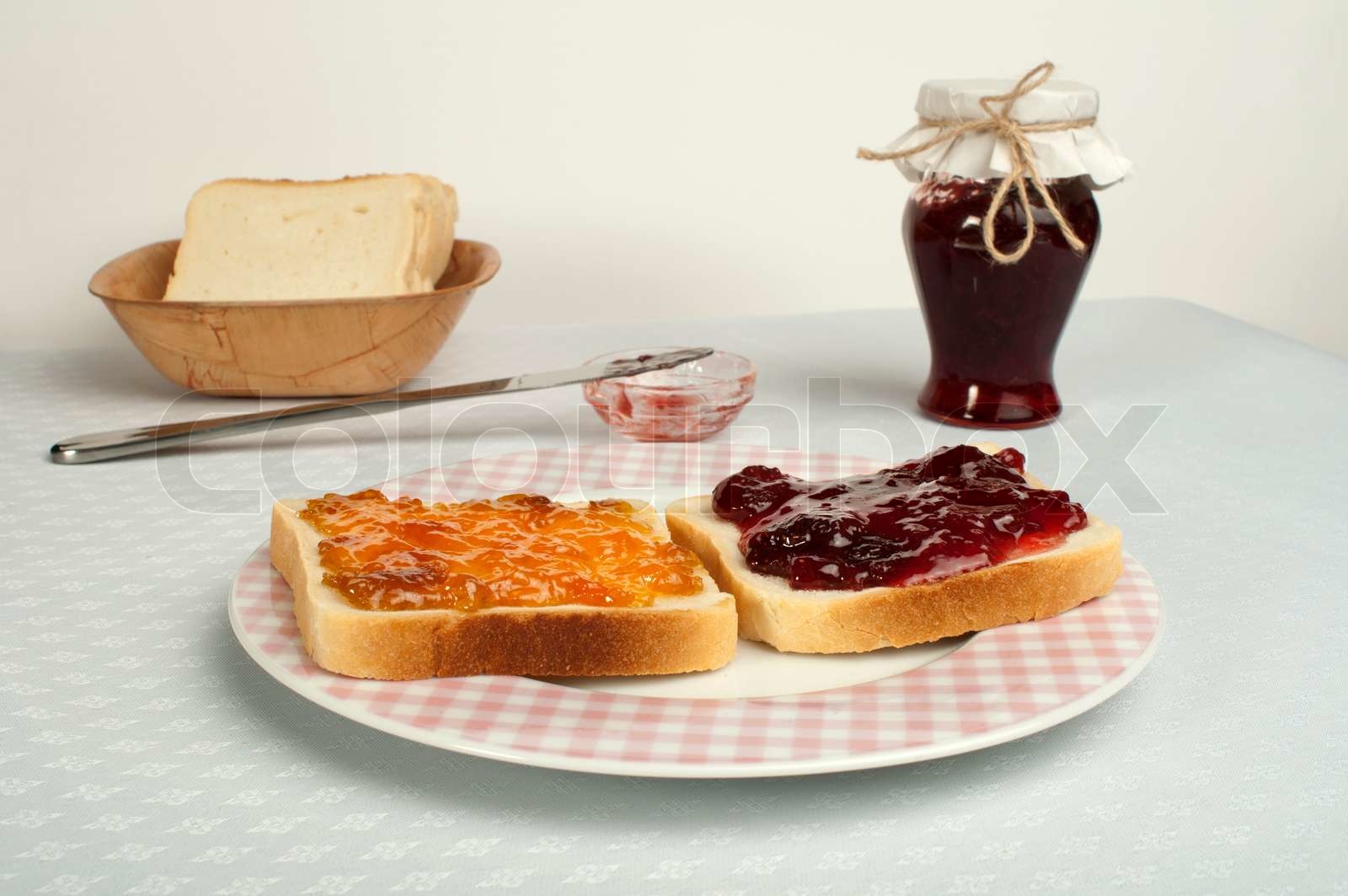Spread jam on bread | Stock image | Colourbox
