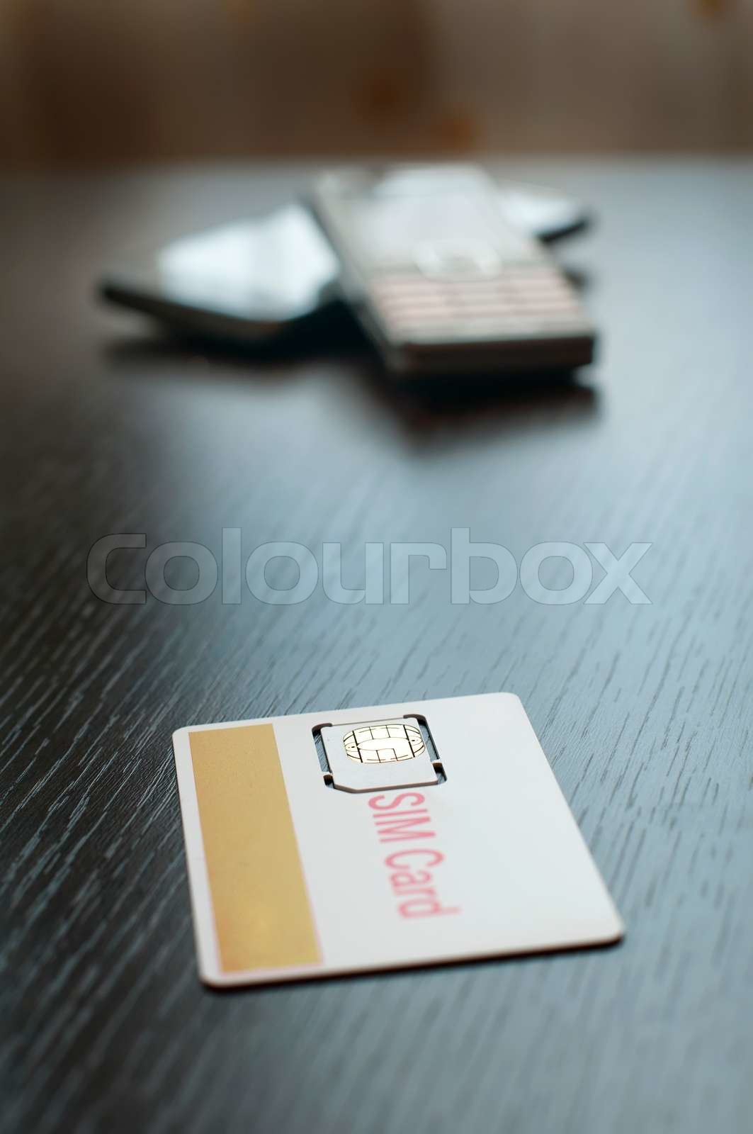 SIM card and mobile phone | Stock image | Colourbox