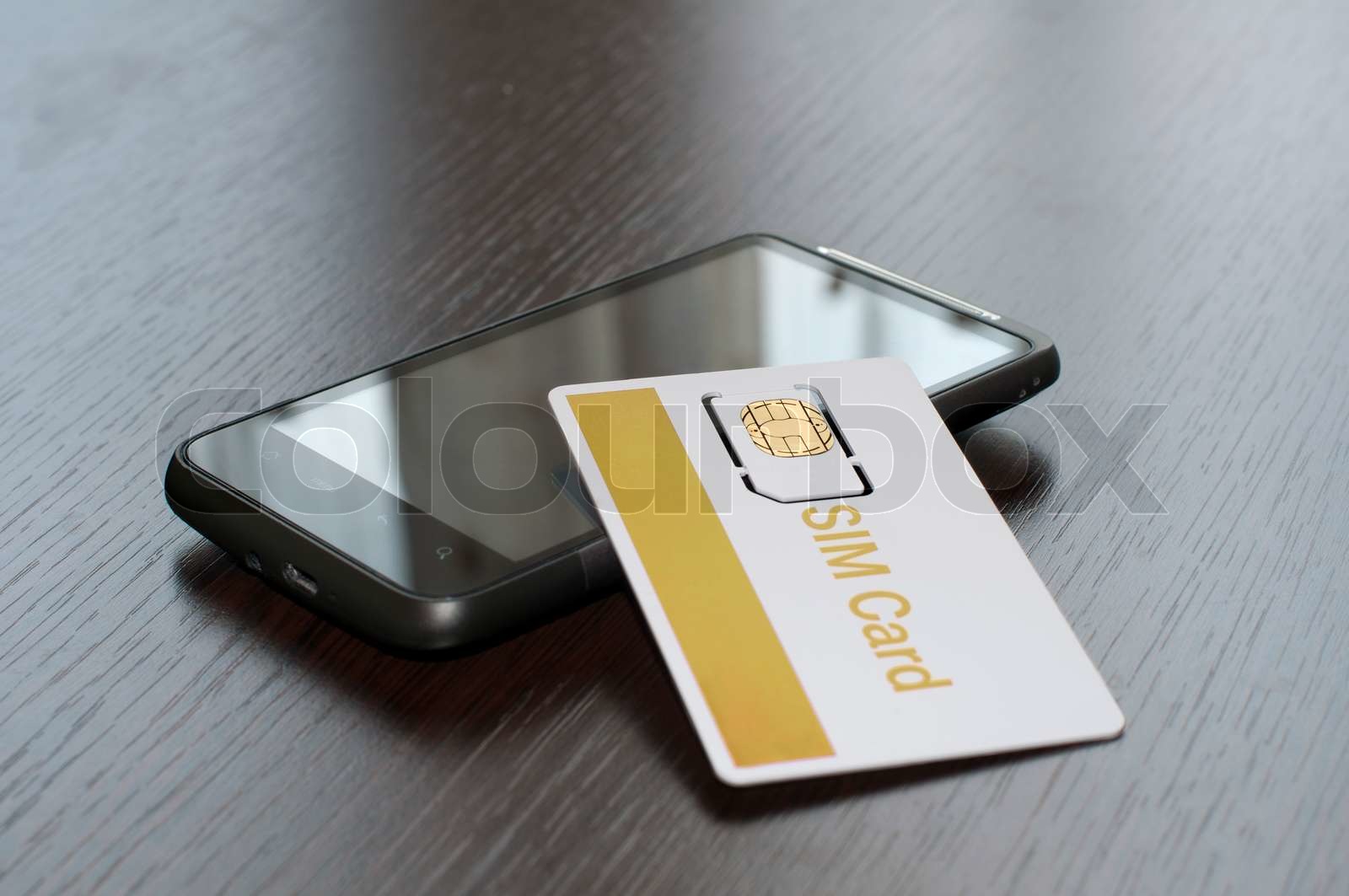 SIM card and mobile phone | Stock image | Colourbox