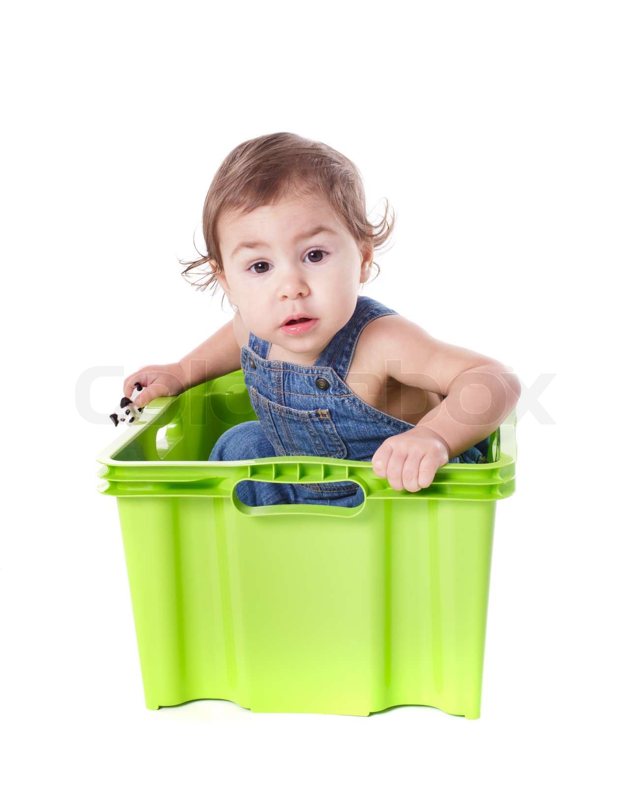 Kid plays with container | Stock image | Colourbox