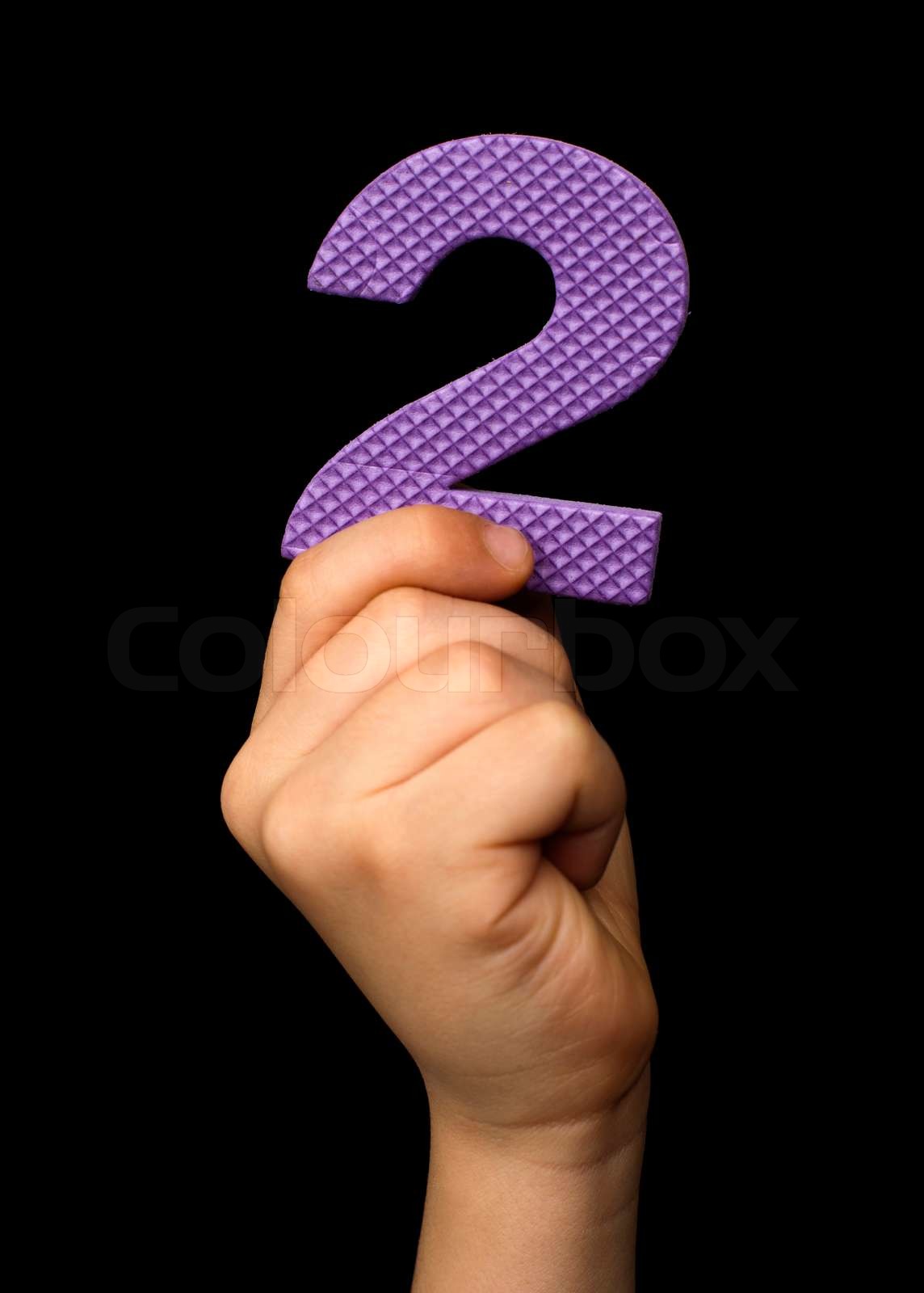 Children hand holding the number Two | Stock image | Colourbox