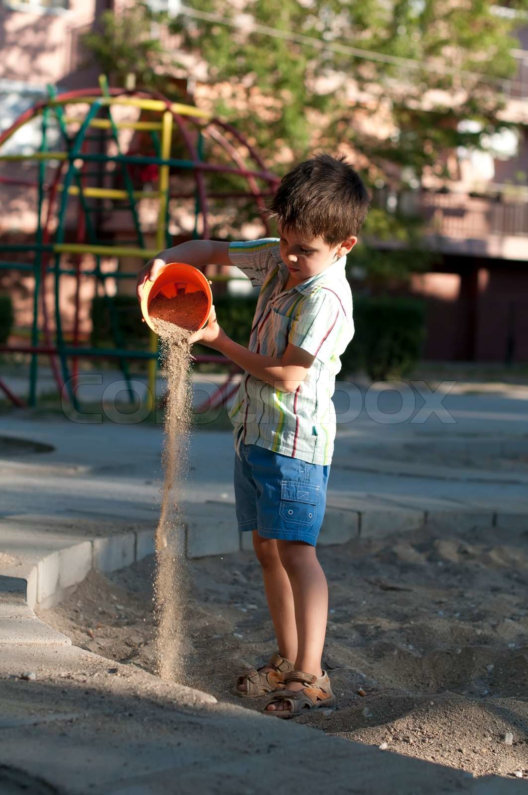 Children pour sand | Stock image | Colourbox