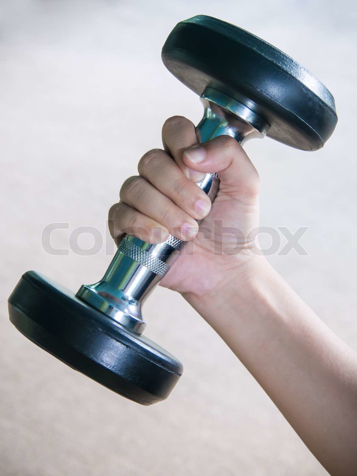 Hand with dumbbell | Stock image | Colourbox