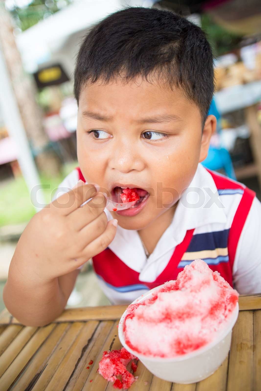 Asian boy eating ice cream | Stock image | Colourbox