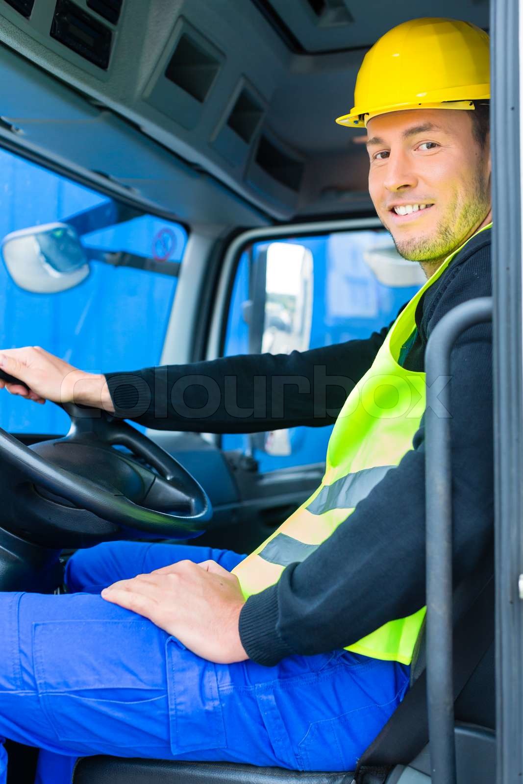 builder driving with truck of construction site | Stock image | Colourbox