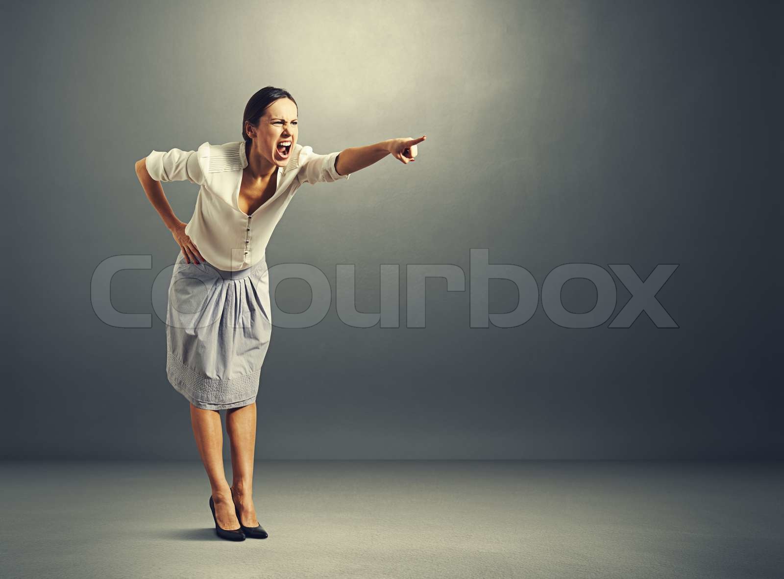 screaming young woman pointing | Stock image | Colourbox