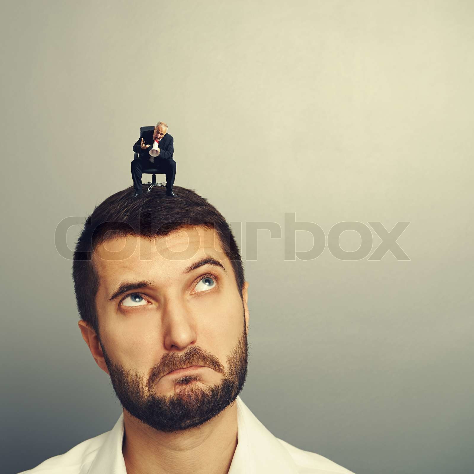 man screaming at big confused man | Stock image | Colourbox