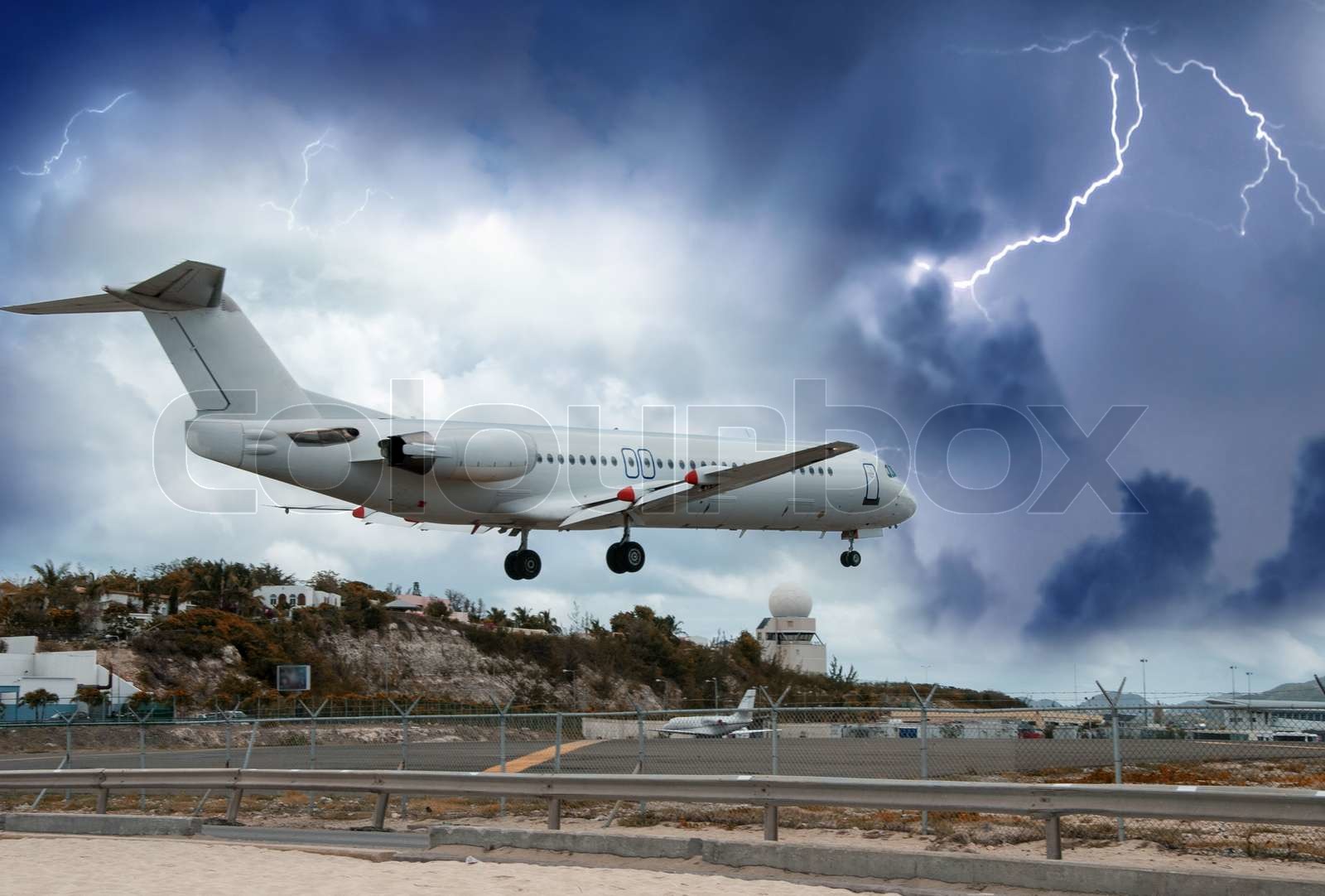 Airplane landing in the storm | Stock image | Colourbox