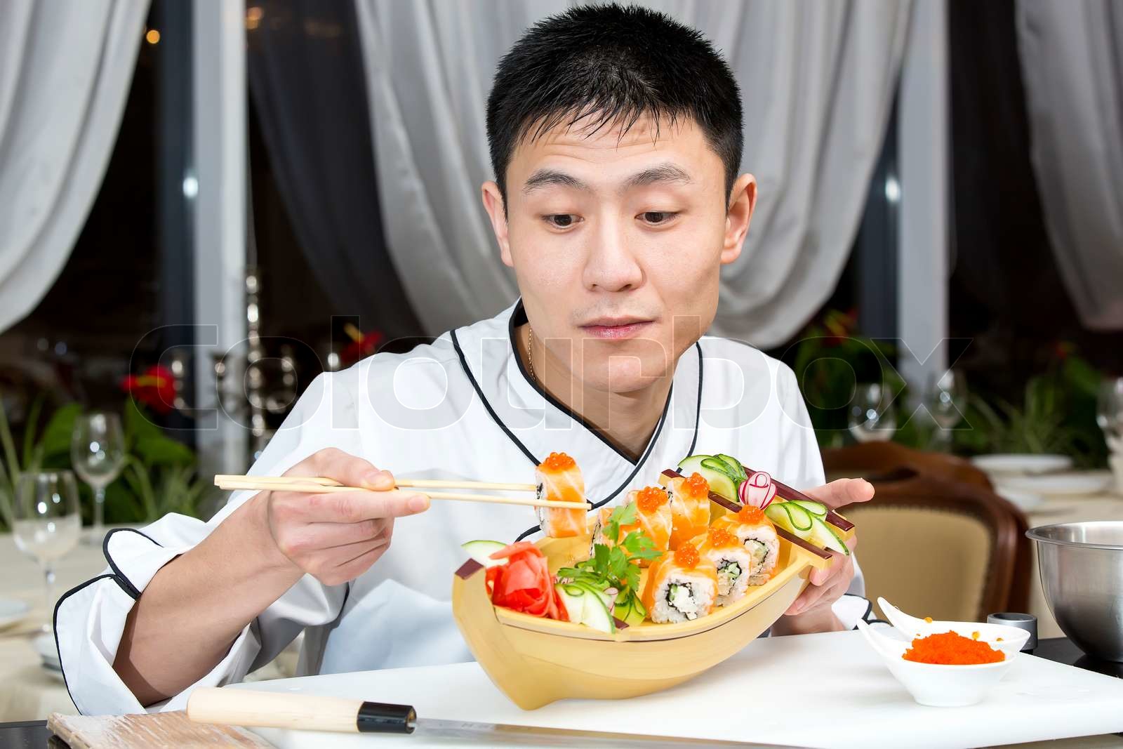 Japanese chef preparing a meal in a restaurant | Stock image | Colourbox