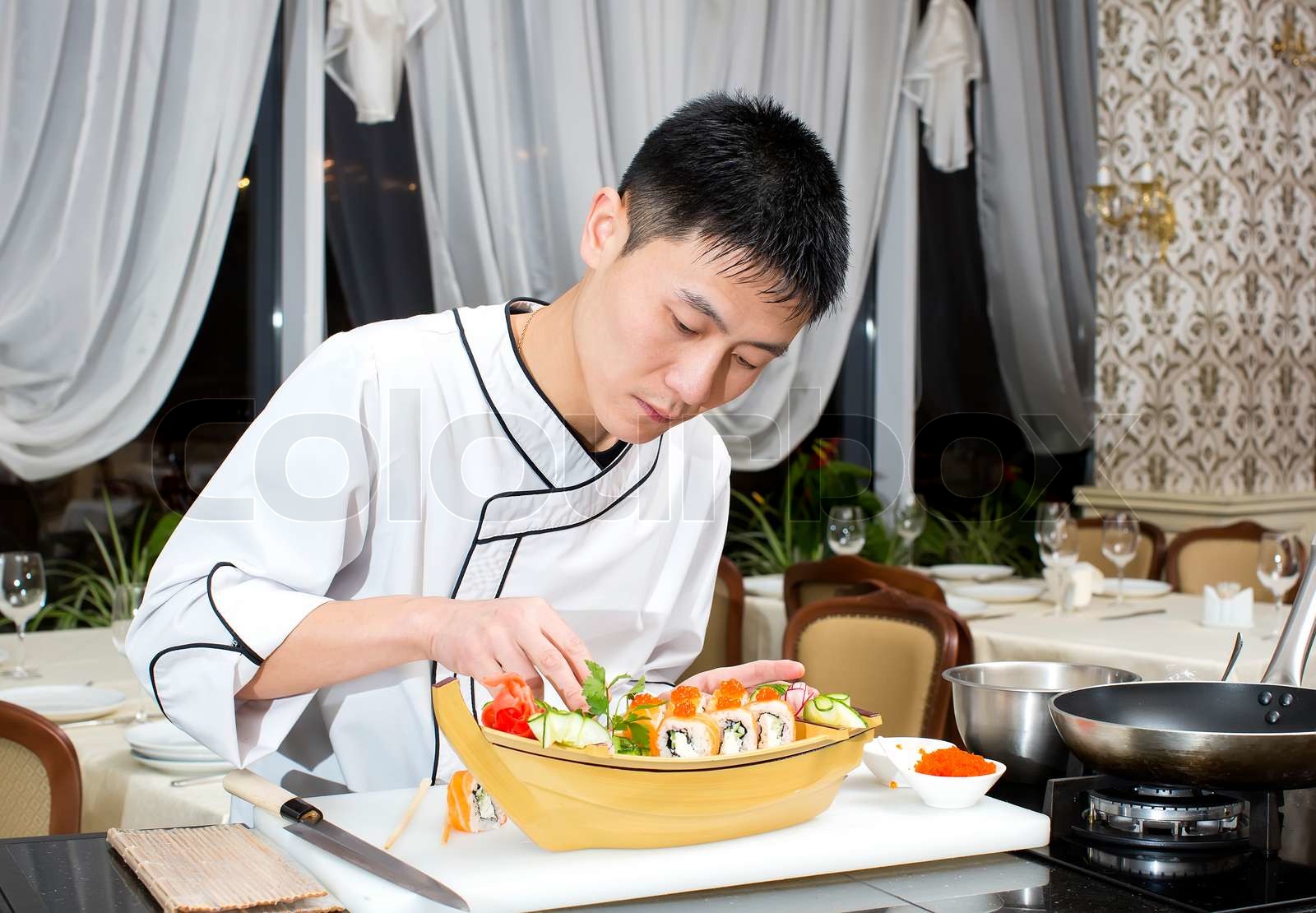 Japanese chef preparing a meal in a restaurant | Stock image | Colourbox