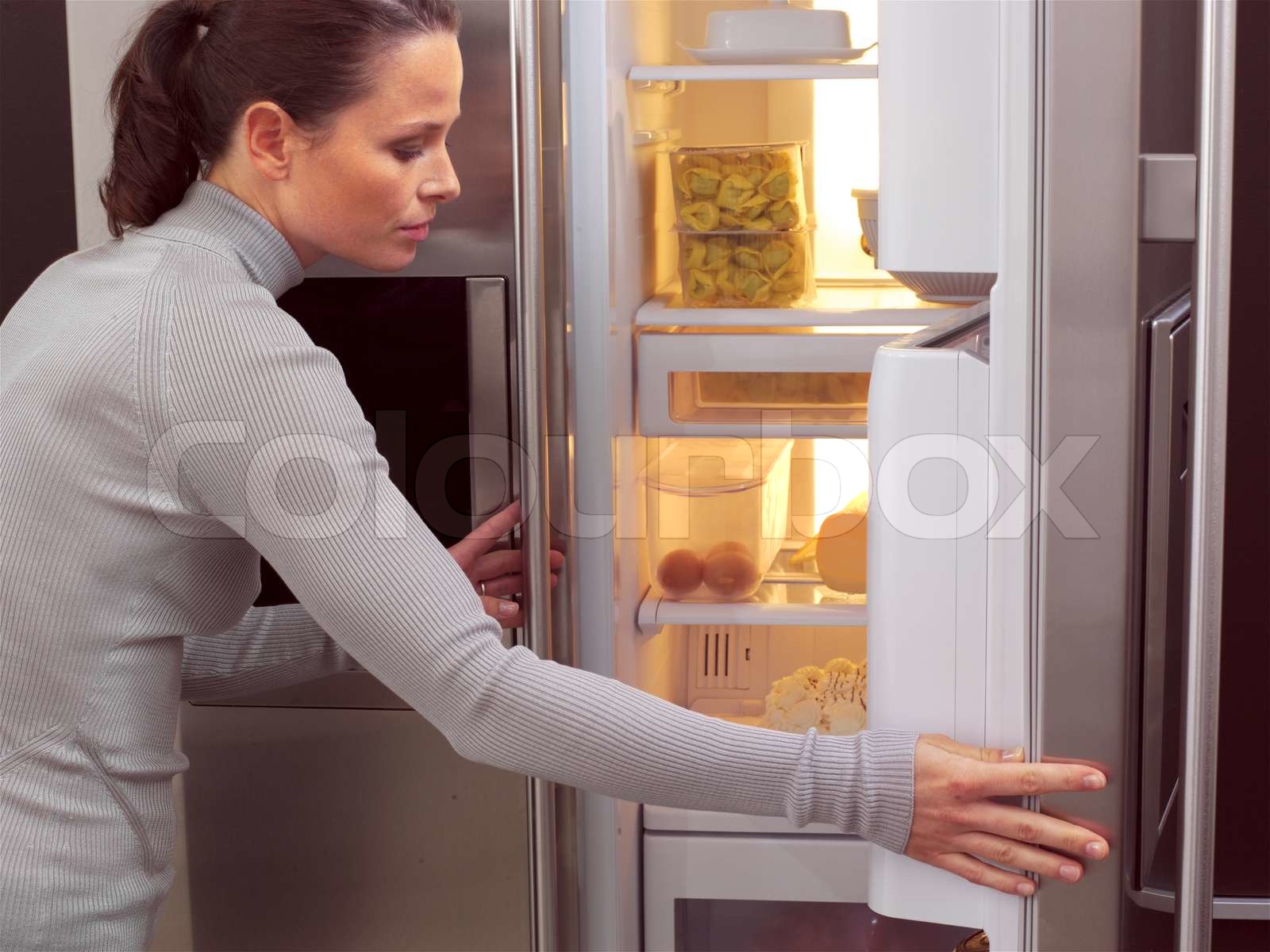 woman in front of the fridge aa | Stock image | Colourbox