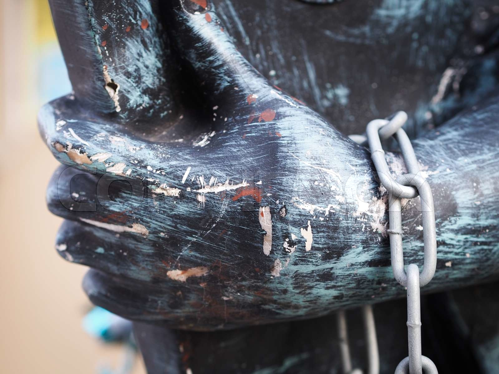 Chain on a hand of a statue | Stock image | Colourbox