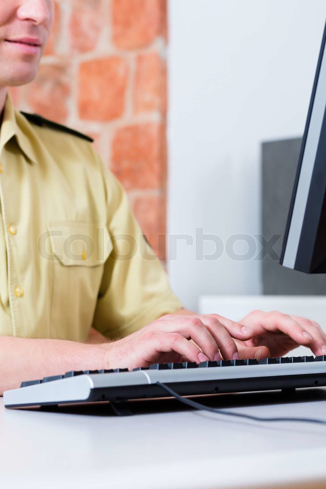 Police Officer working on desk in department | Stock image | Colourbox