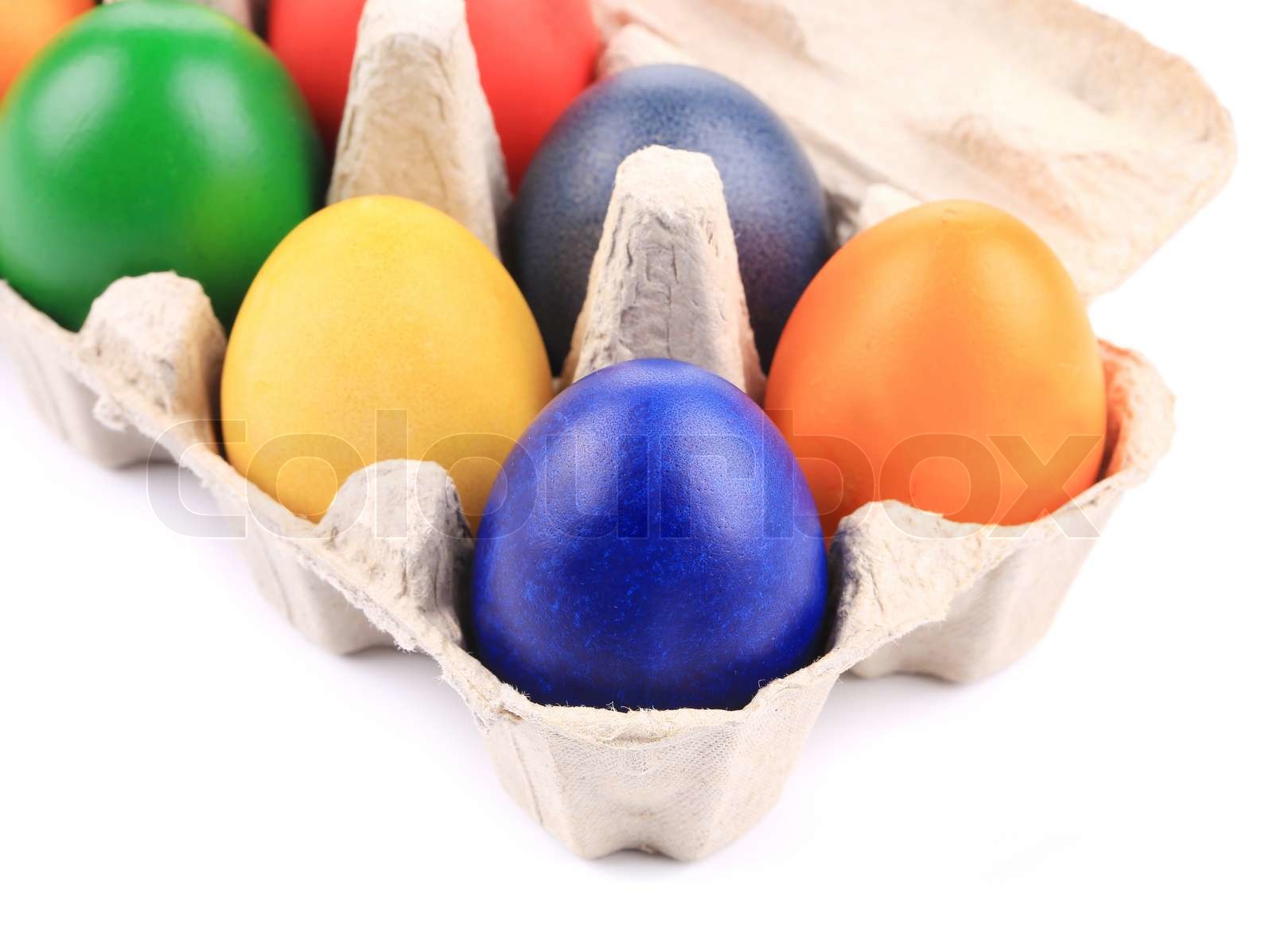 Cardboard egg box with Easter colored eggs. | Stock image | Colourbox
