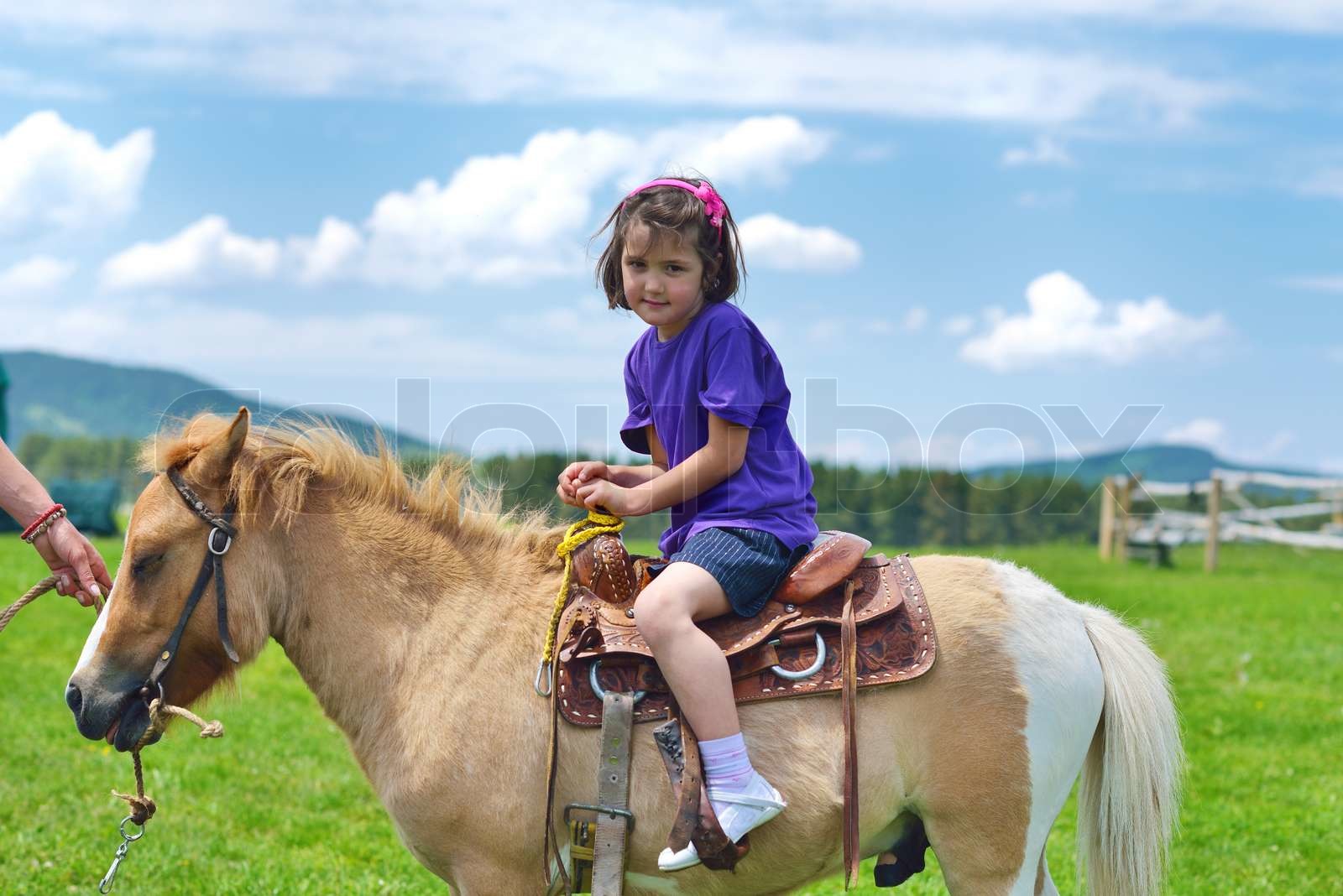 child ride pony | Stock image | Colourbox