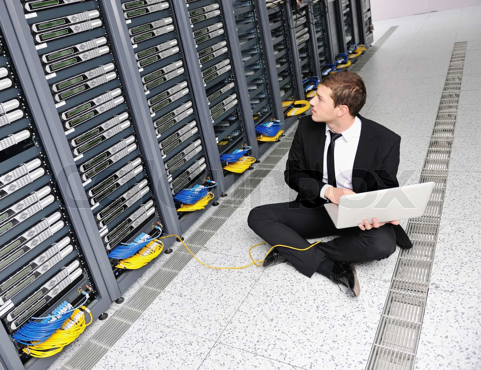 businessman with laptop in network server room | Stock image | Colourbox