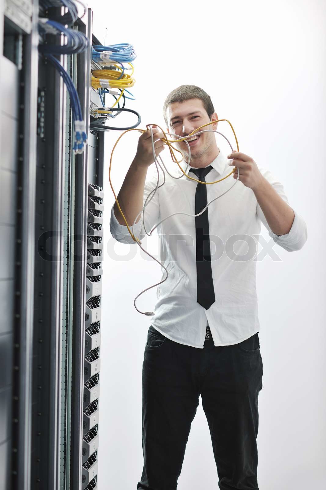 young engeneer in datacenter server room | Stock image | Colourbox