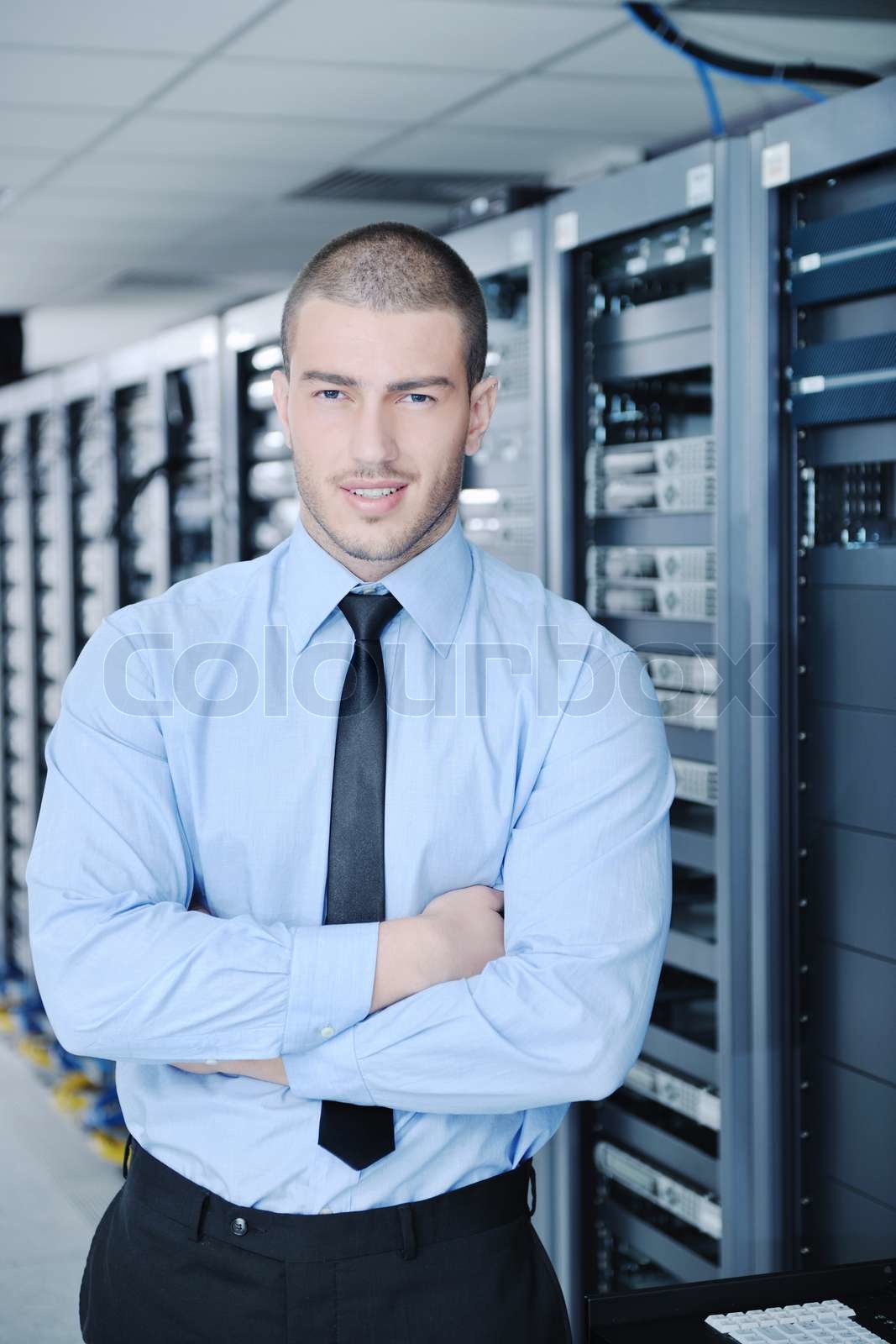young it engineer in datacenter server room | Stock image | Colourbox