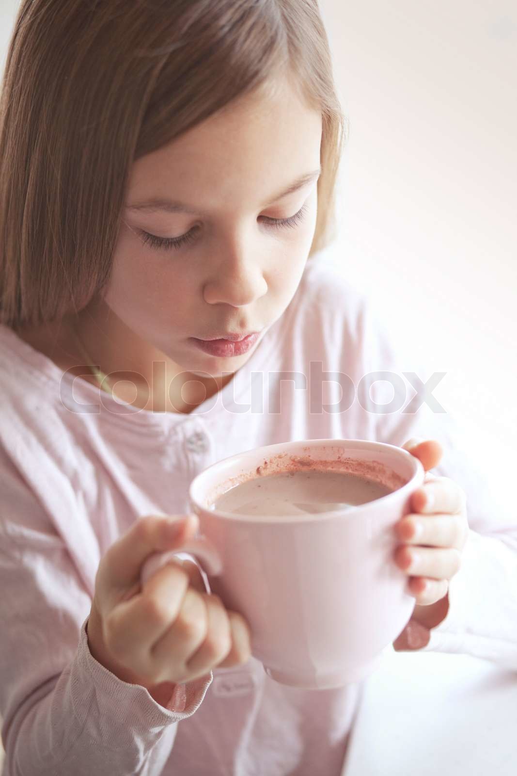 Child drinking cocoa | Stock image | Colourbox