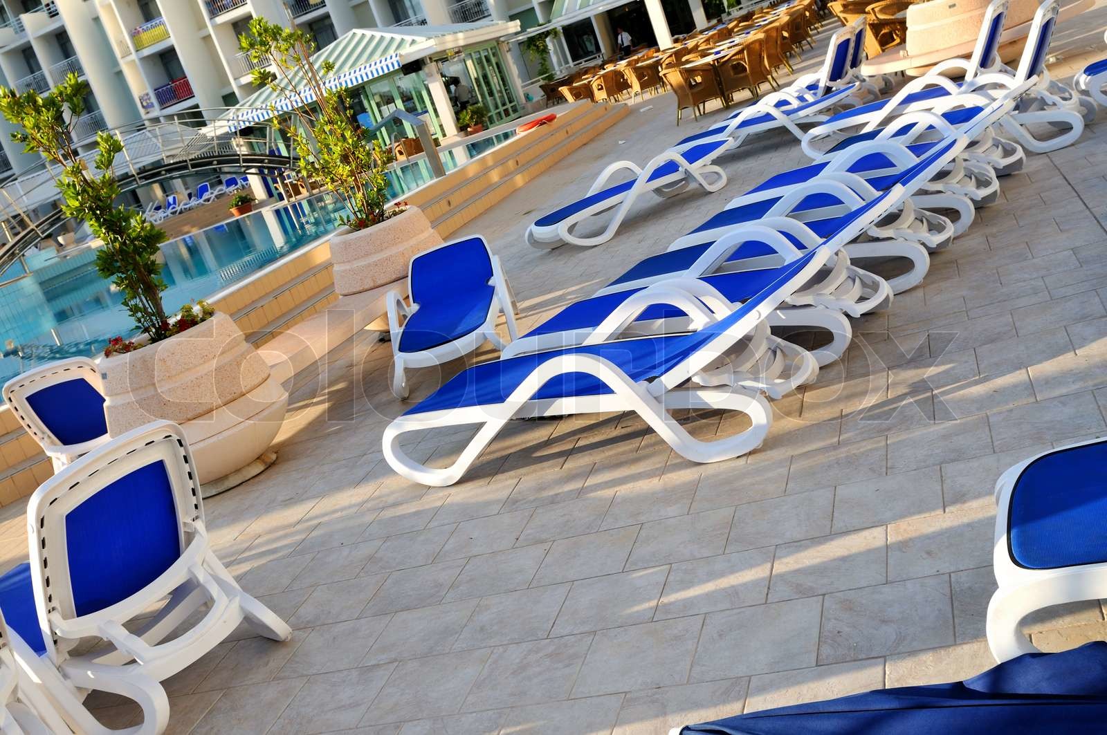 Empty chairs by the pool of hotel | Stock image | Colourbox