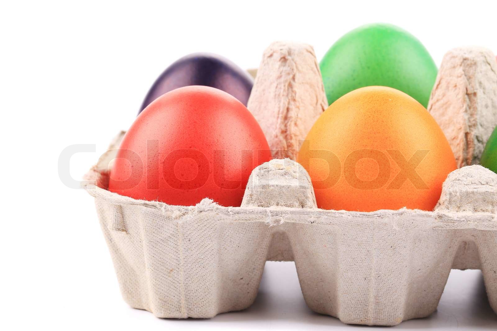 Cardboard egg box with Easter colored eggs | Stock image | Colourbox
