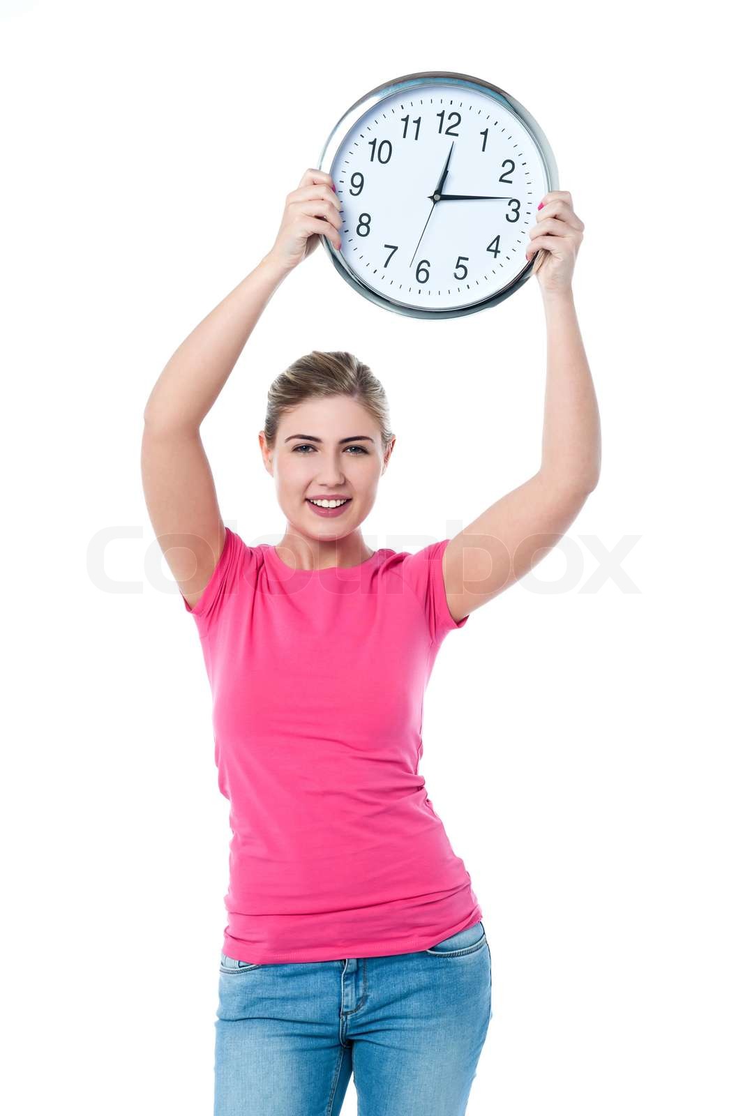 Pretty girl holding the wall clock | Stock image | Colourbox