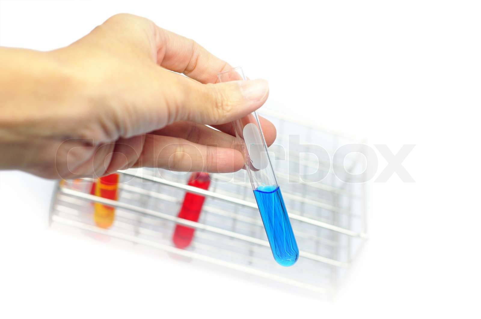 Hand holding test tube | Stock image | Colourbox