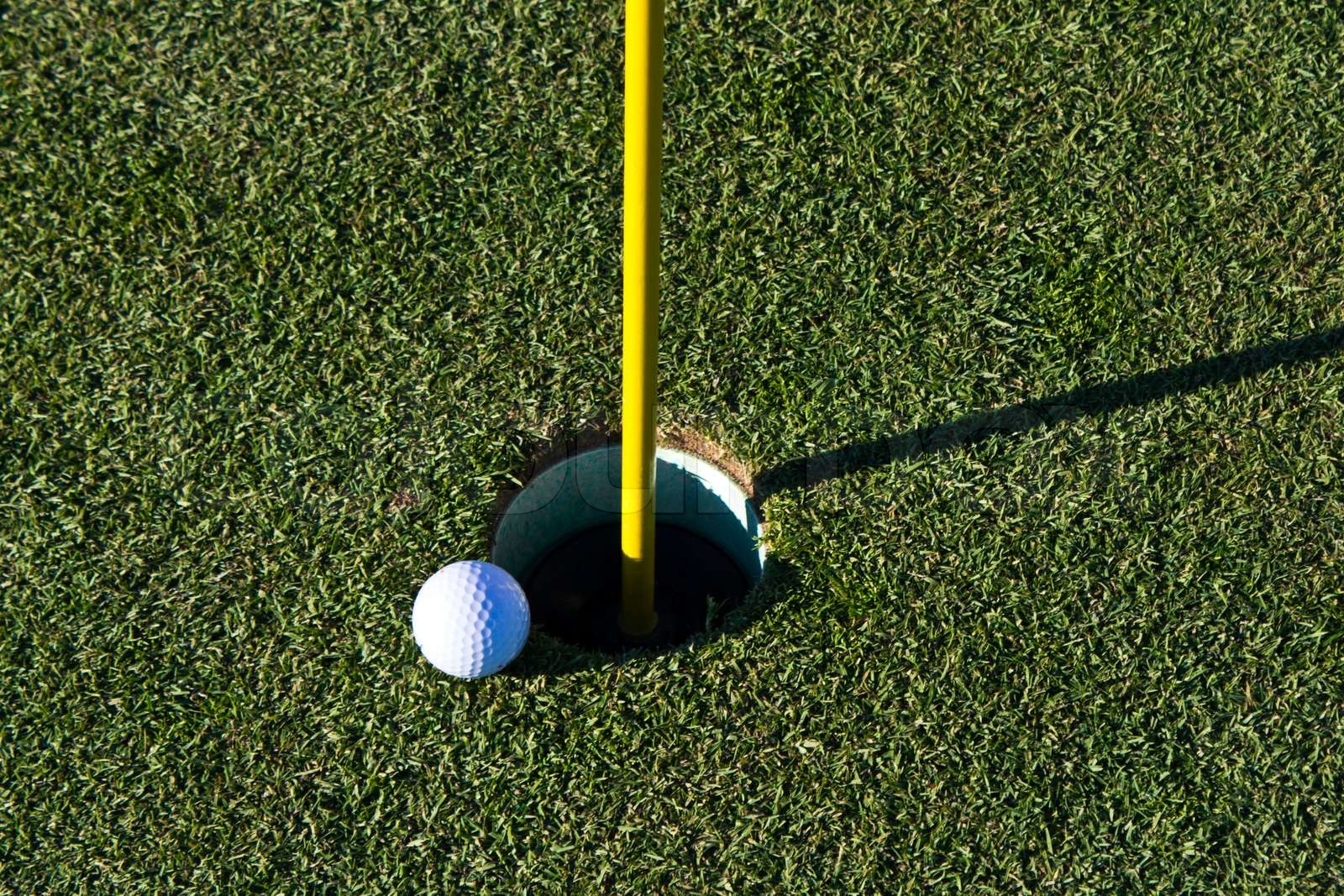 Golf ball on the edge of the cup | Stock image | Colourbox