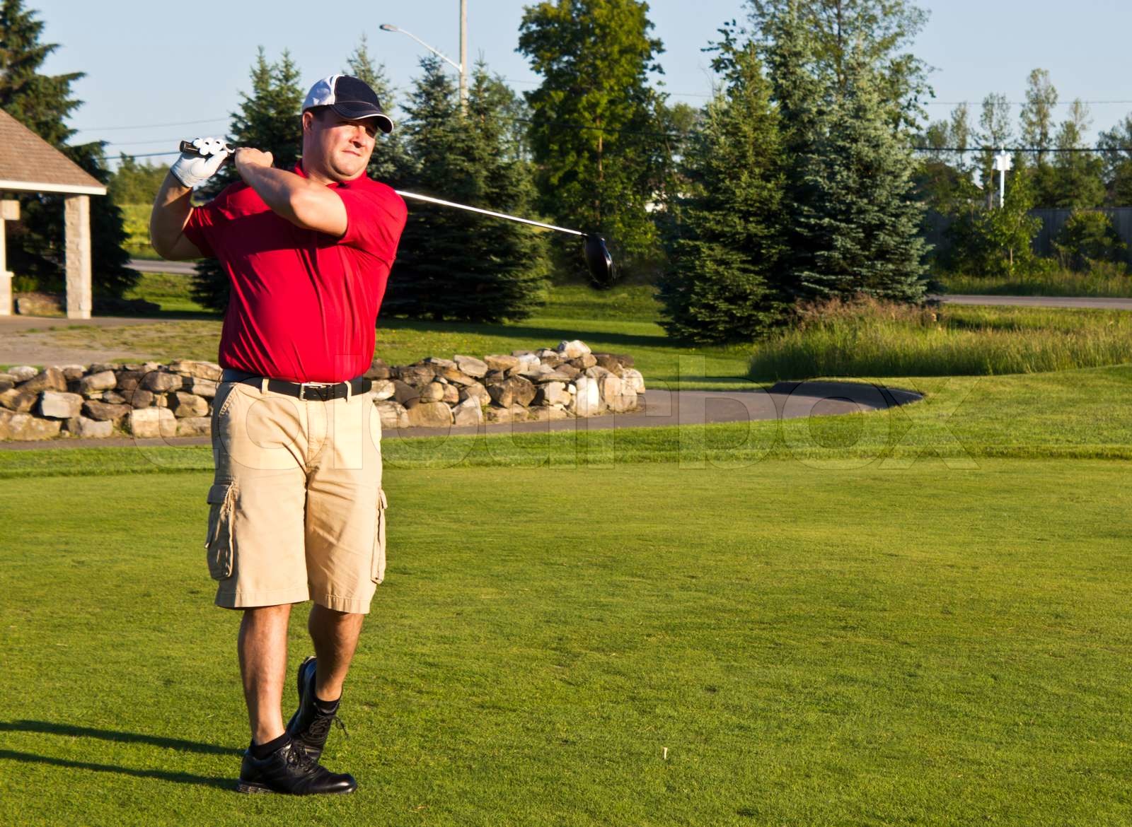 Golfer hitting the ball on the tee | Stock image | Colourbox