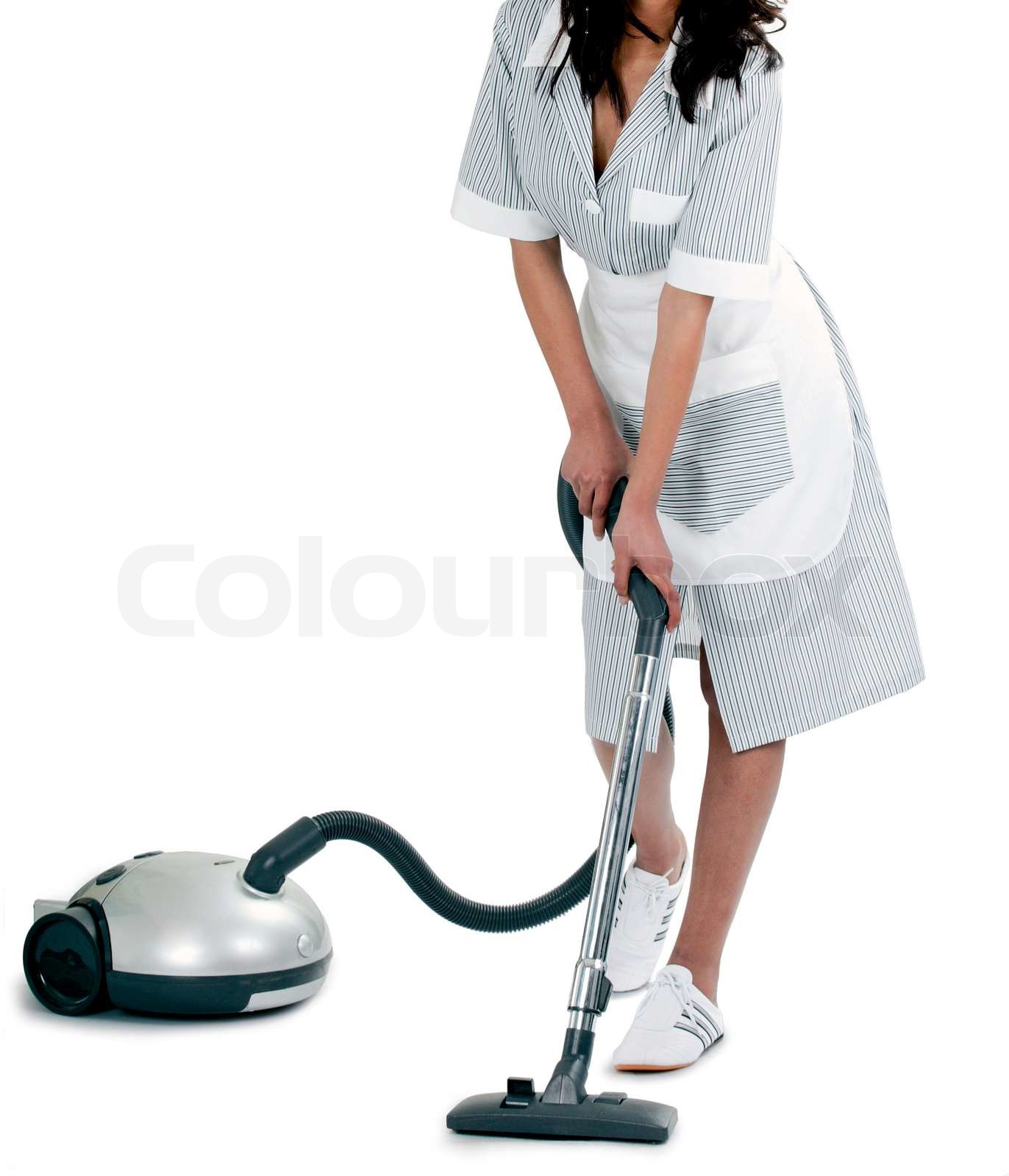 Maid doing housework with vacuum cleaner | Stock image | Colourbox