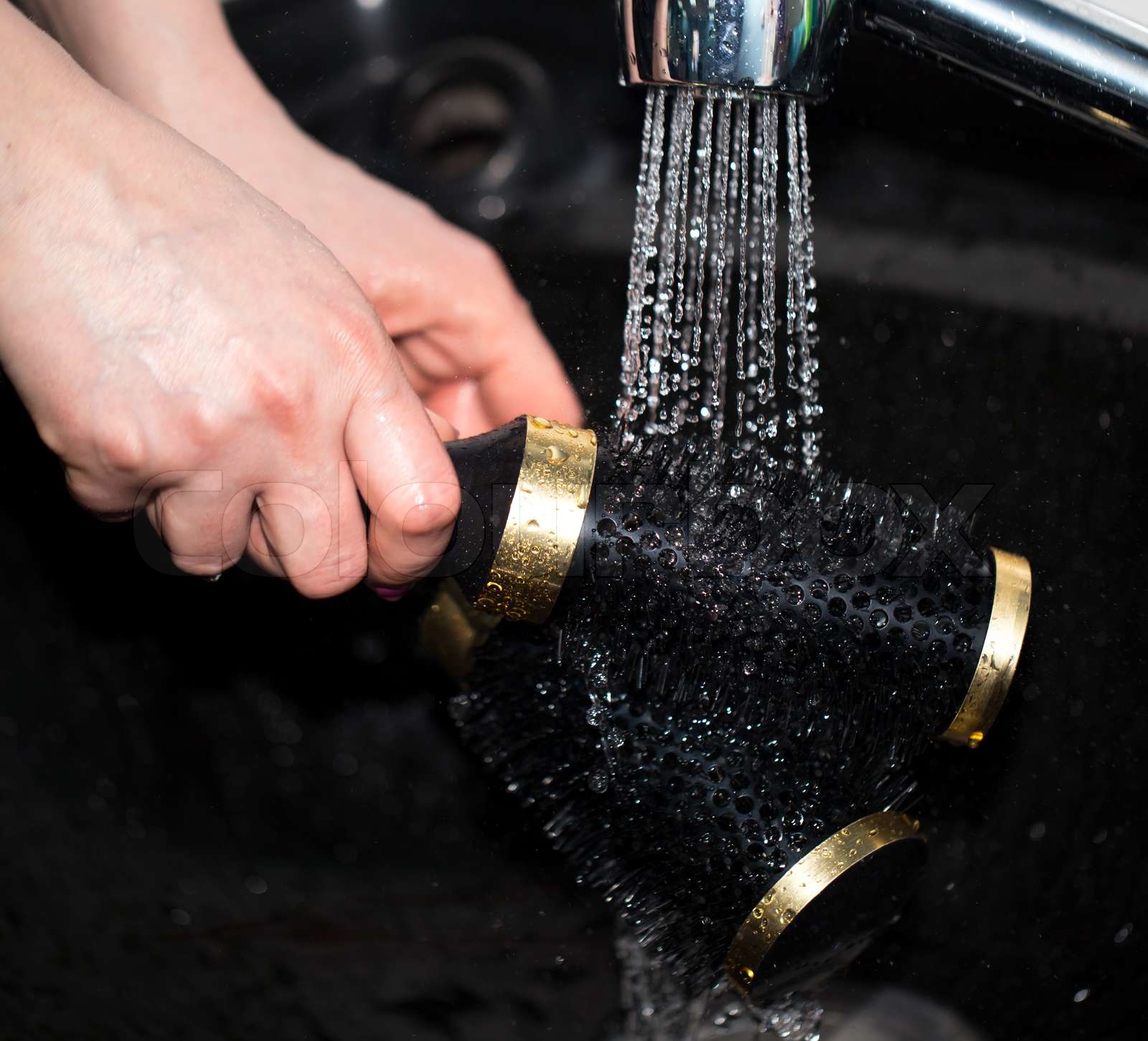 Wash combs with tap water | Stock image | Colourbox