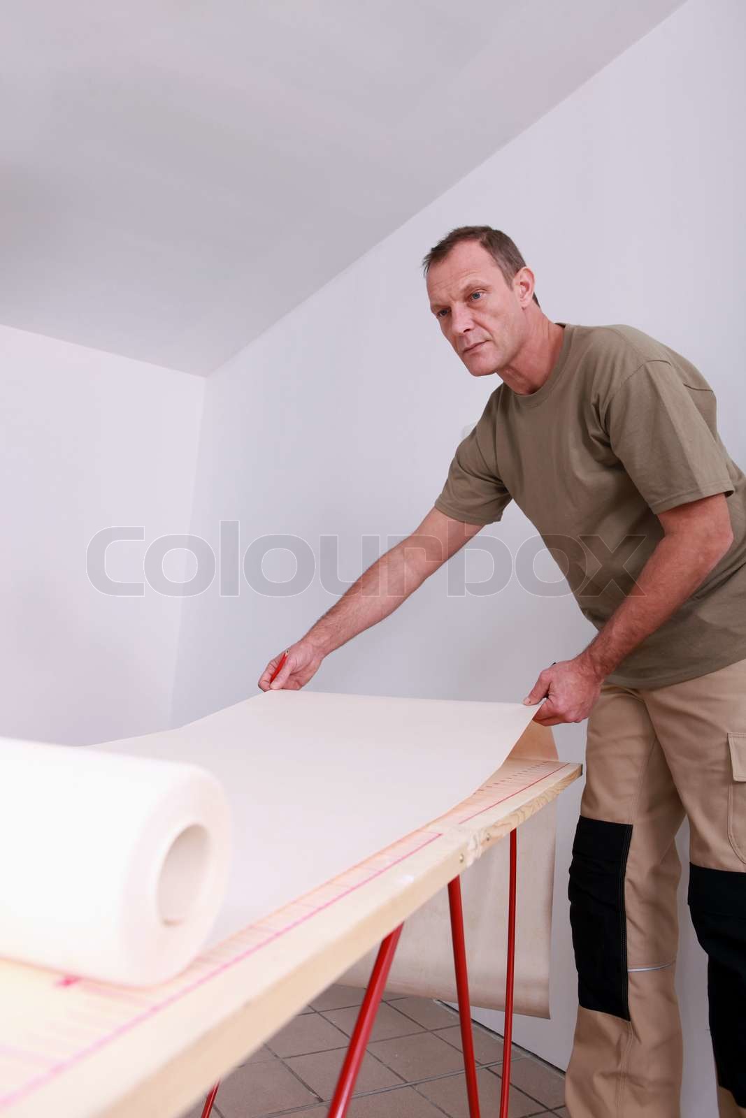 Man unrolling paper | Stock image | Colourbox
