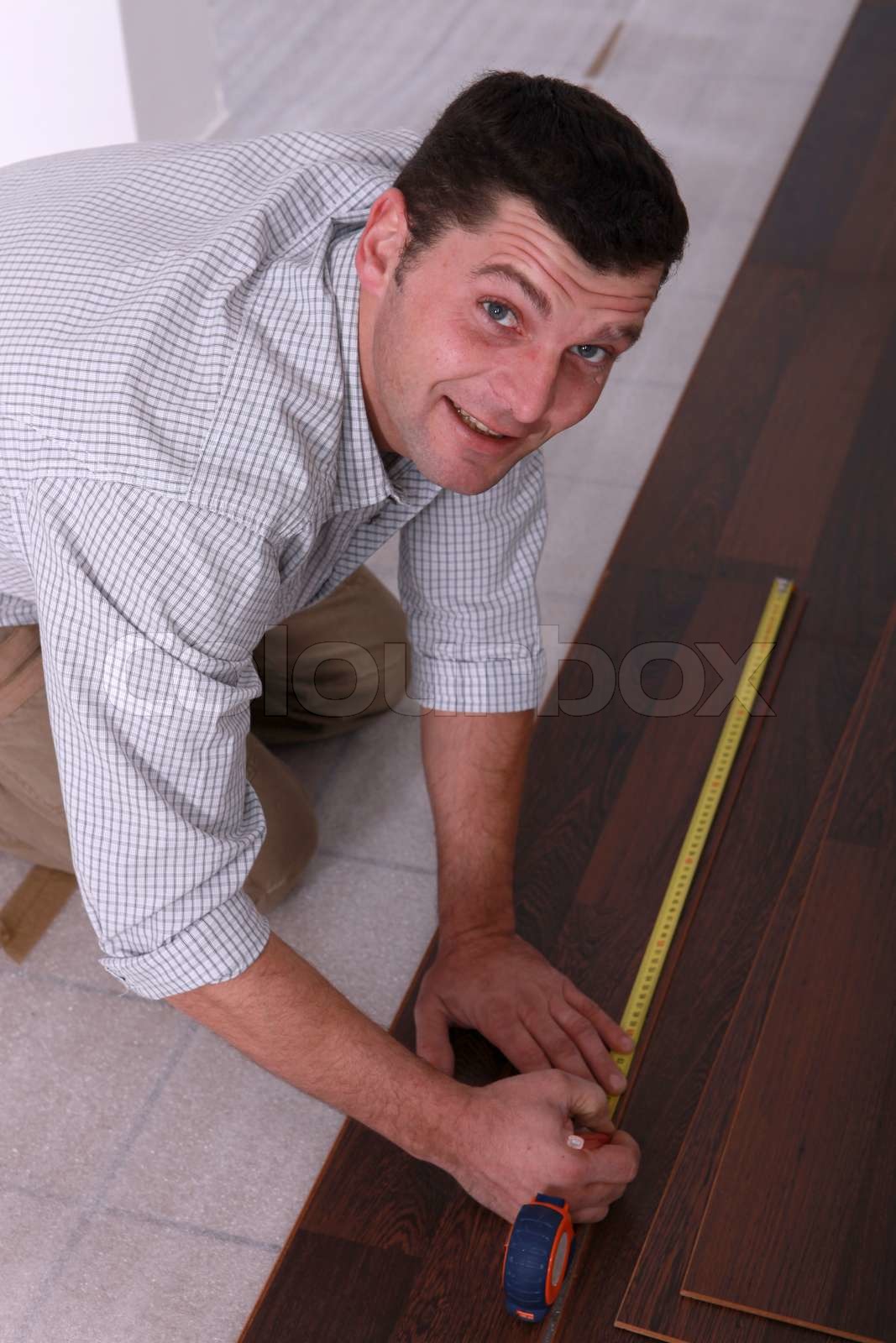 Man using a measuring tape | Stock image | Colourbox
