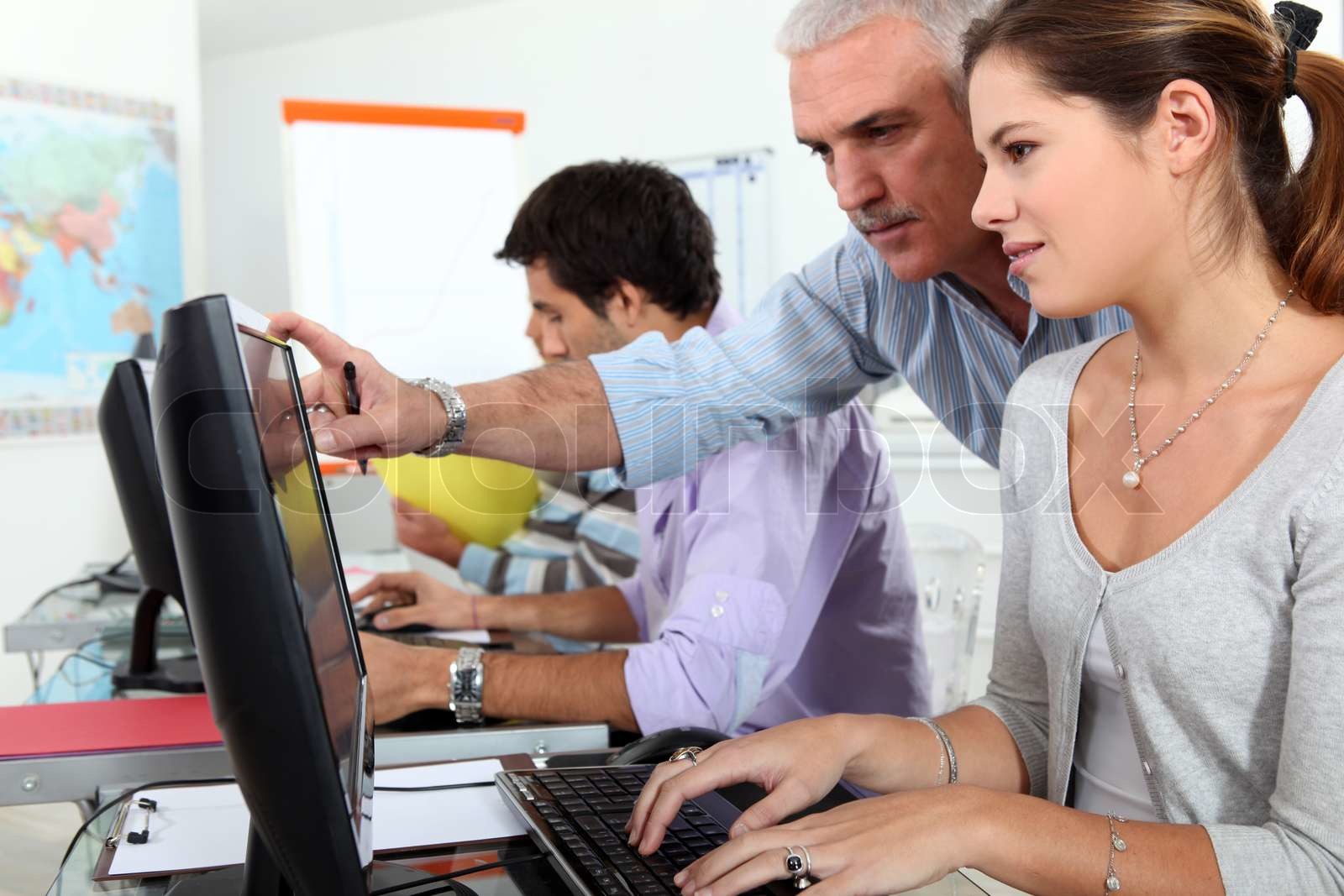 Mature students using computers in a classroom | Stock image | Colourbox