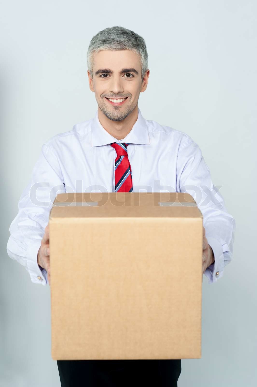 Smiling aged delivery man | Stock image | Colourbox