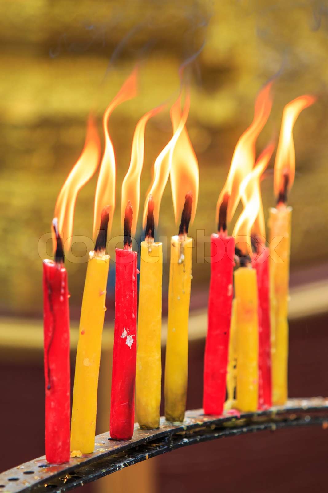 lighting prayer candle offering, sacrificial or memorial candles lit in ...