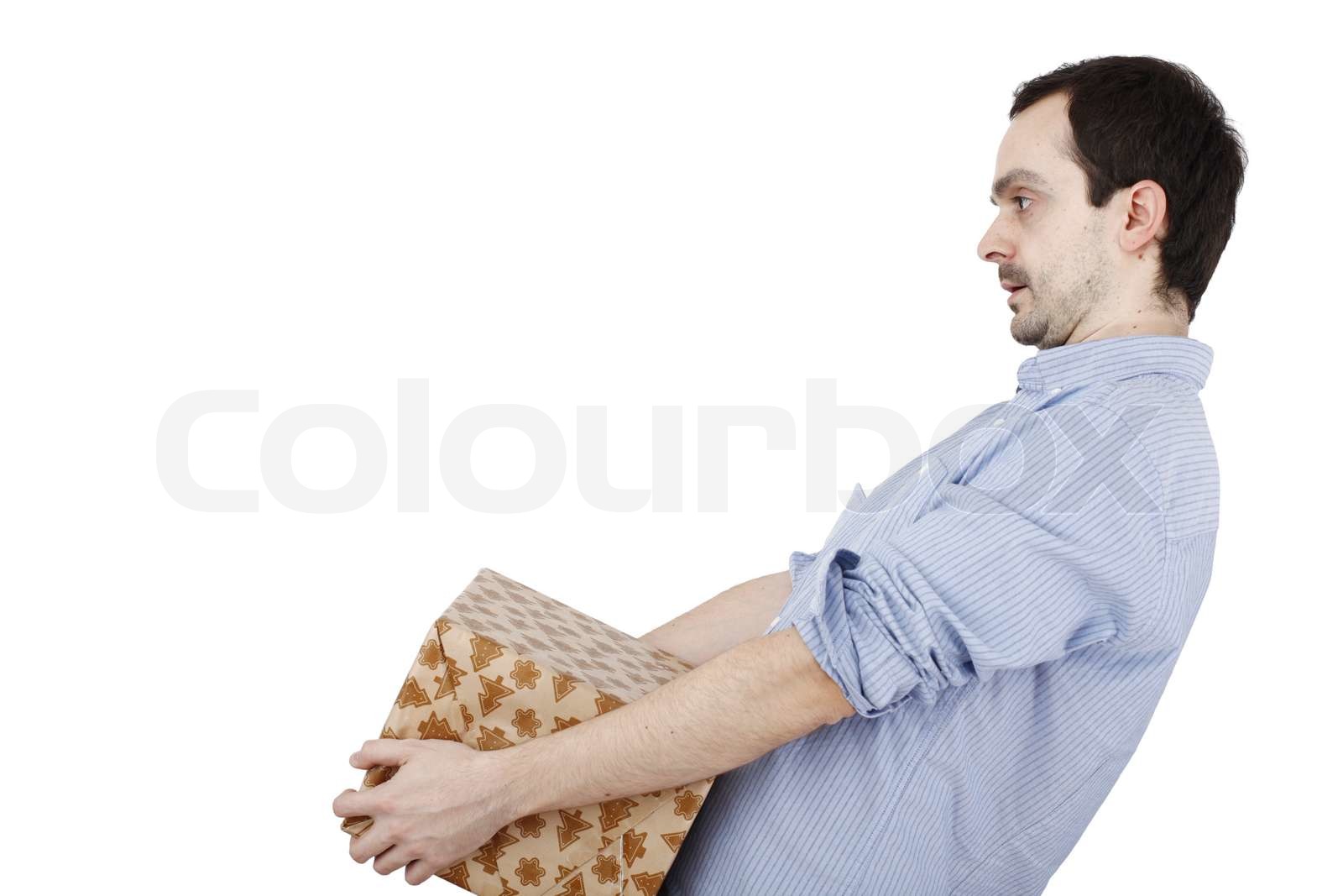 Young man holding a present | Stock image | Colourbox