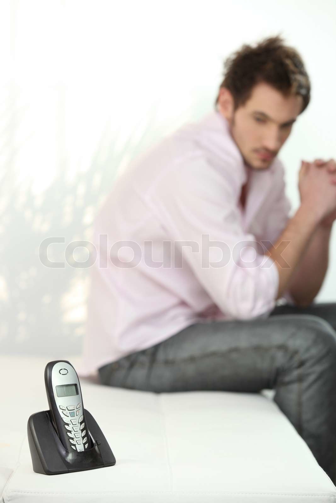Man waiting for phone call | Stock image | Colourbox