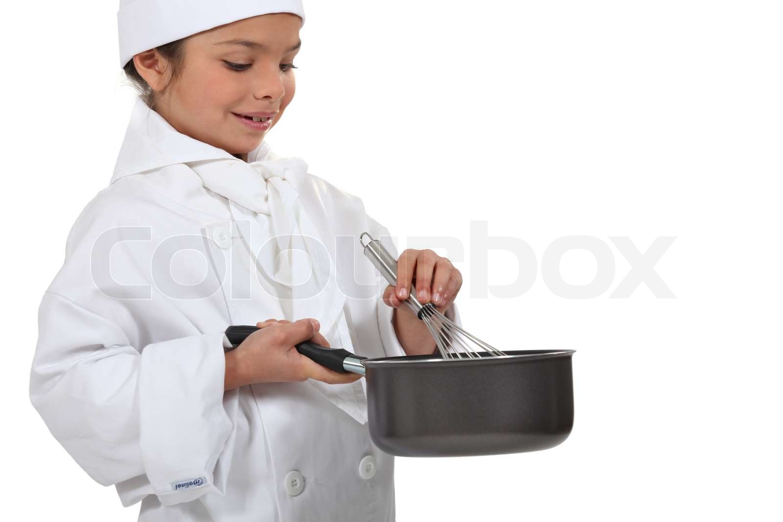 Young chef mixing a sauce | Stock image | Colourbox