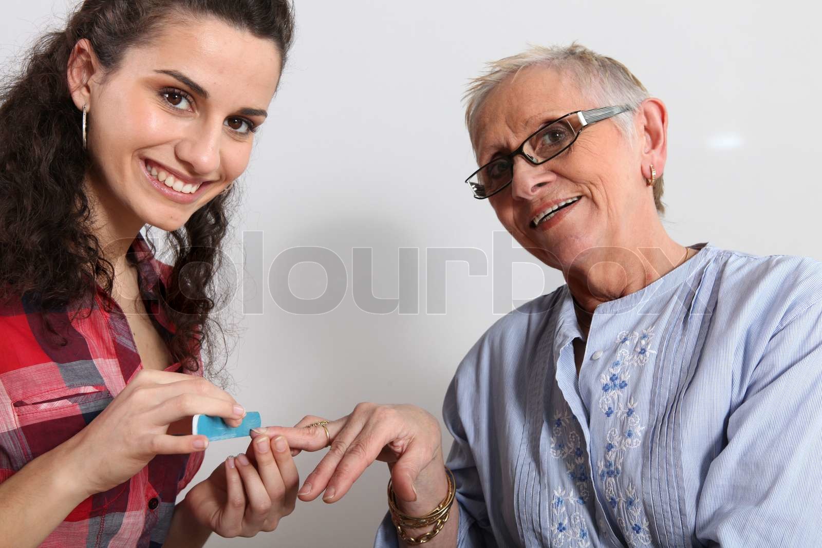 Elderly woman having manicure | Stock image | Colourbox